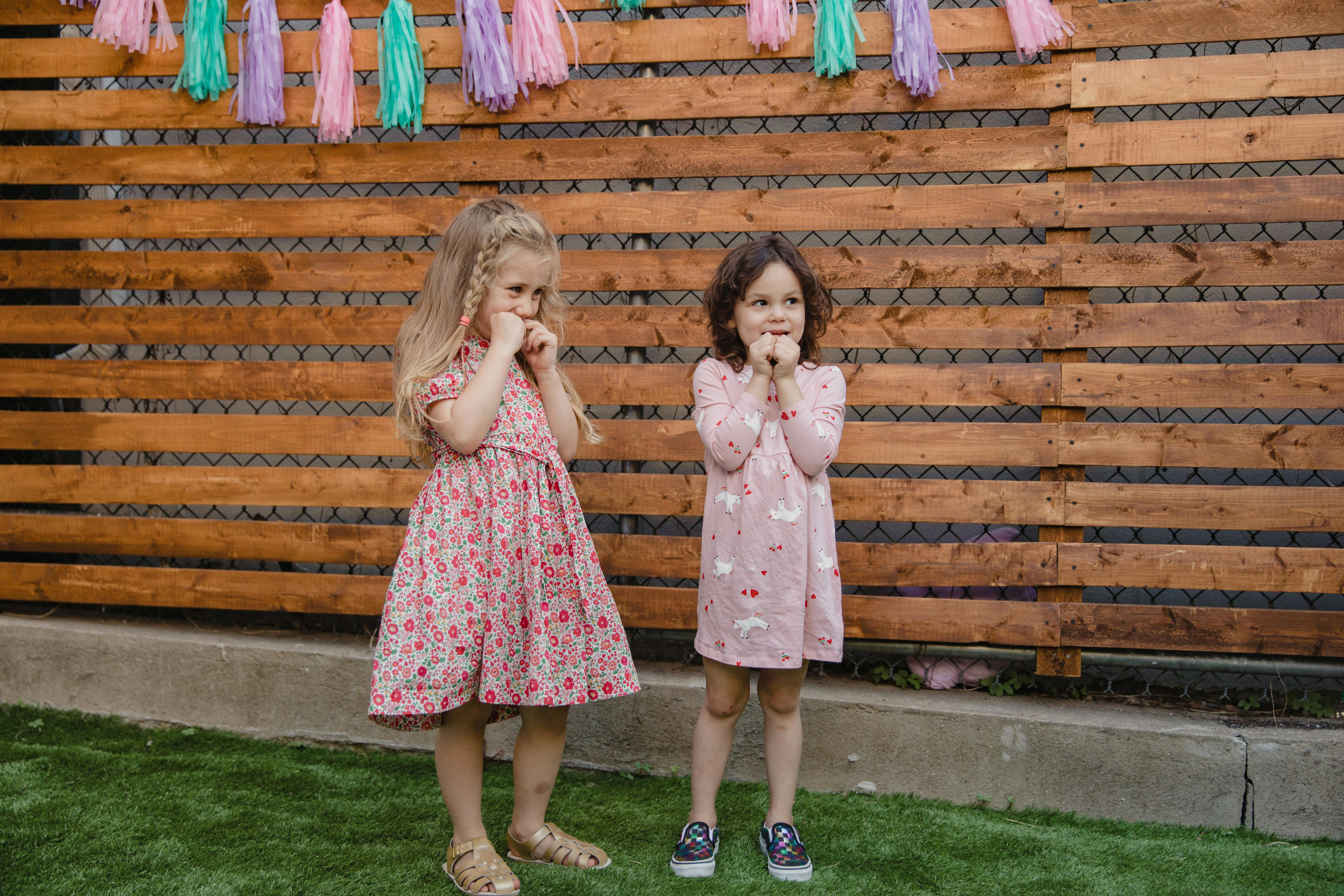 Children Standing Beside a Wooden fence · Free Stock Photo