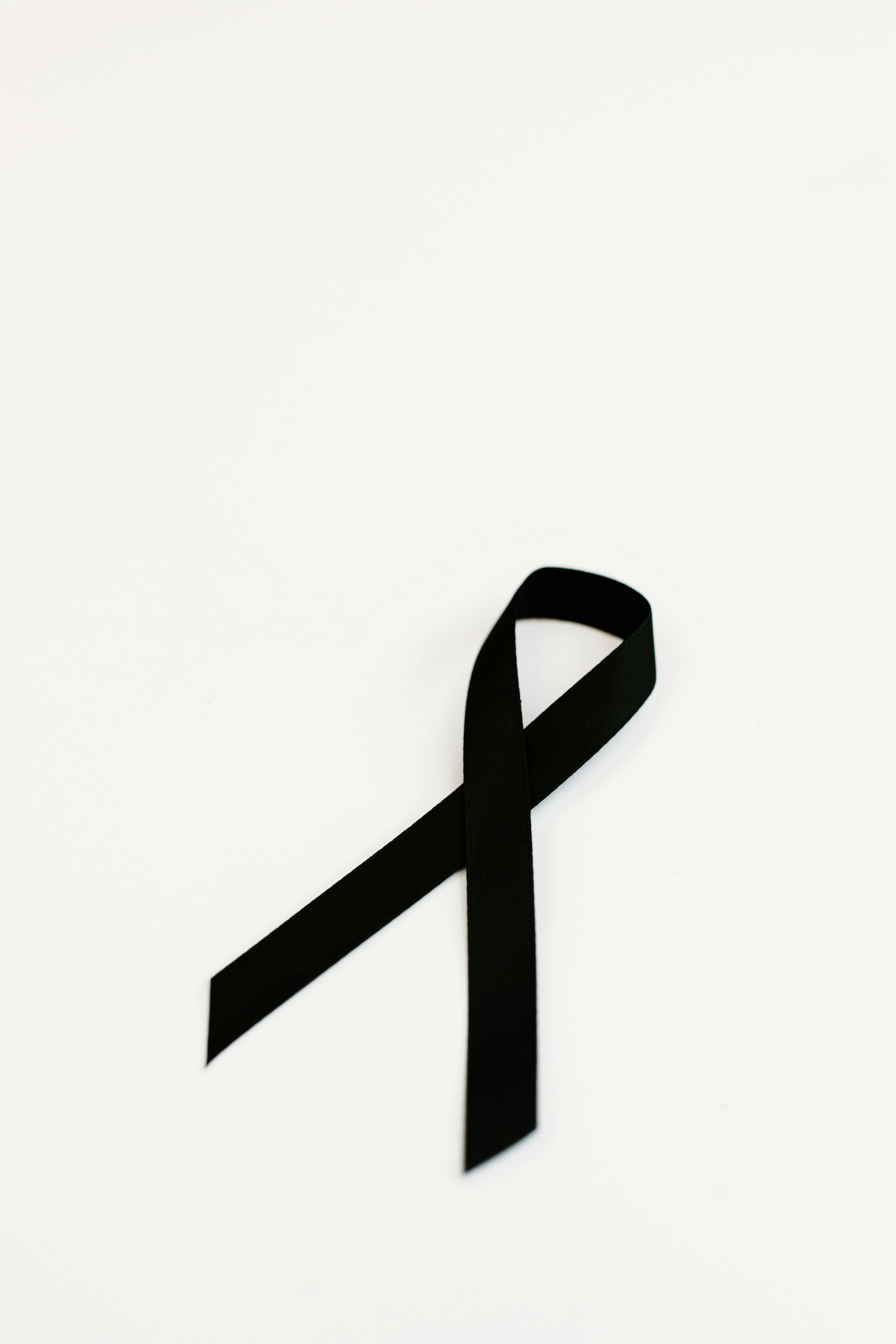 Close-Up Shot of a Black Ribbon on White Background · Free Stock Photo