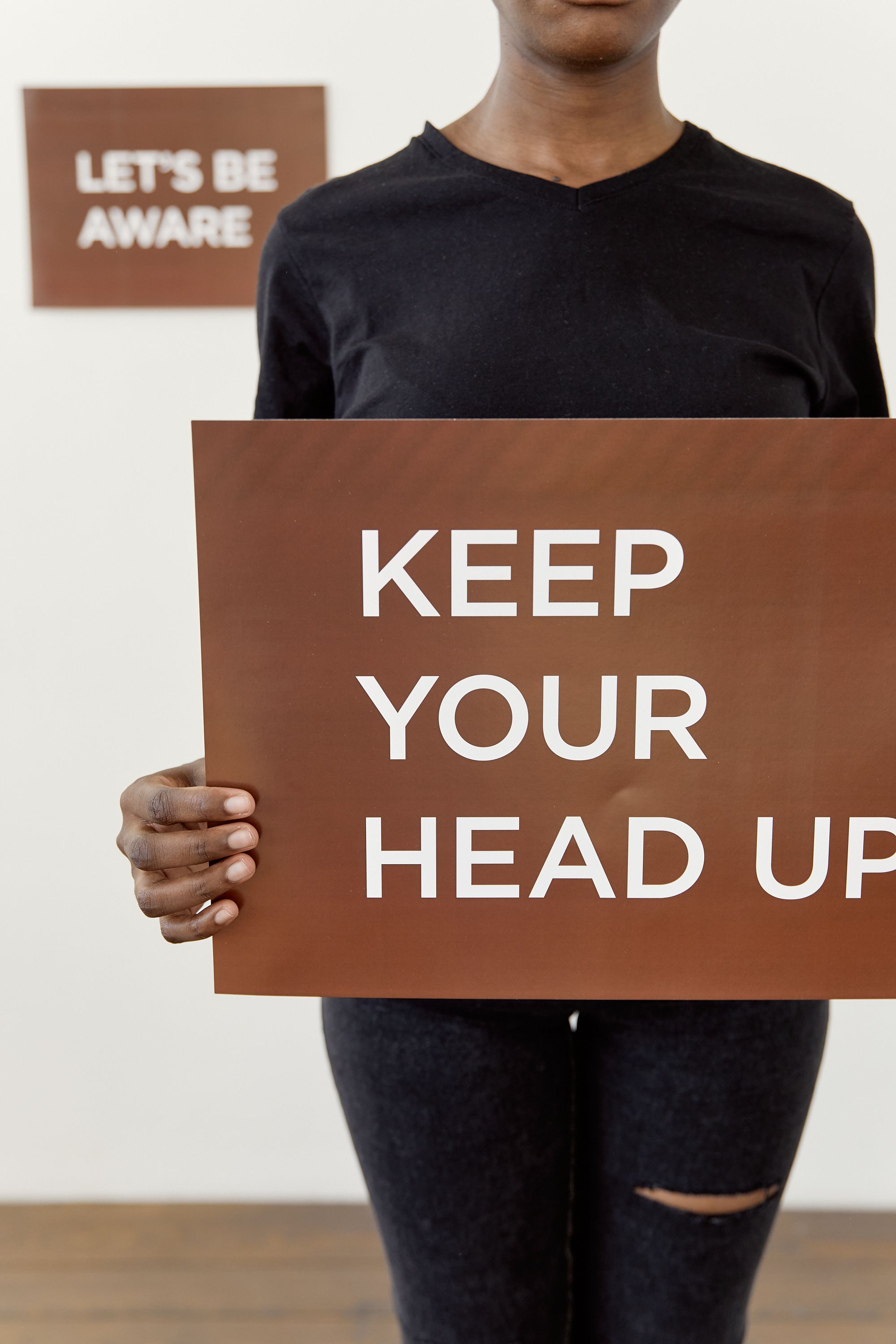 Person holding a Brown Placard · Free Stock Photo