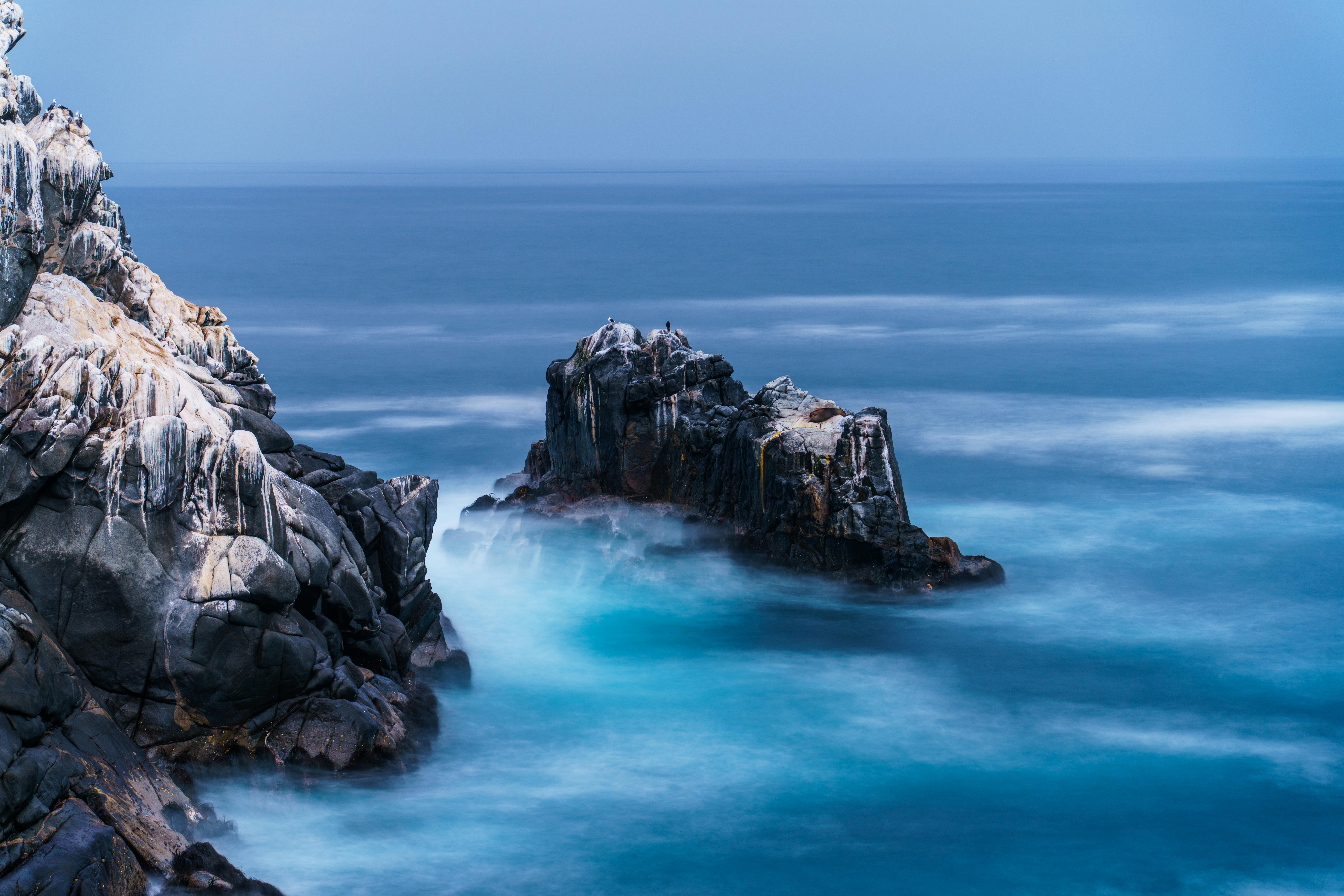 Photo of a Stone Cliff over Water · Free Stock Photo