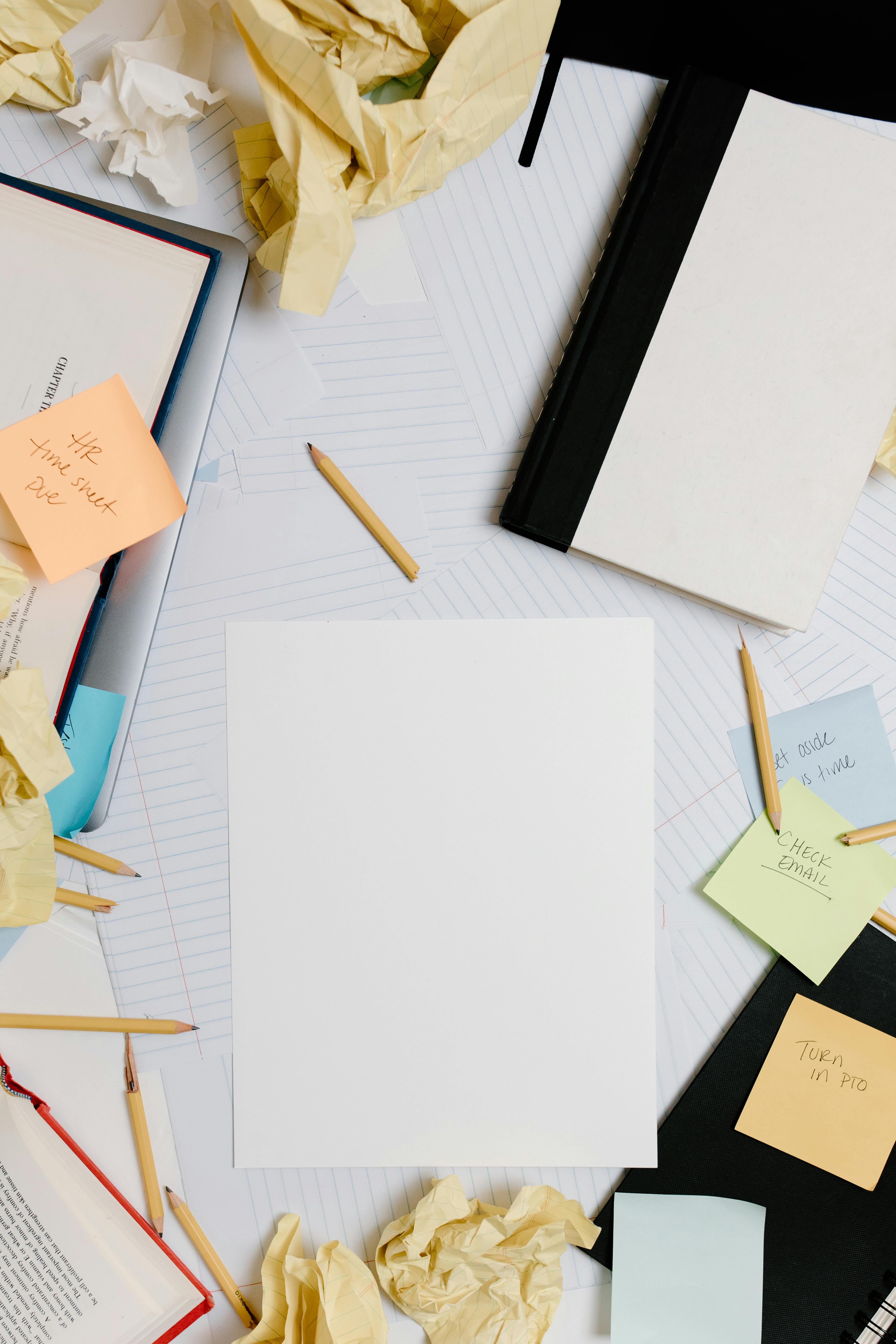 White Printer Paper Near Pencils on the Table · Free Stock Photo
