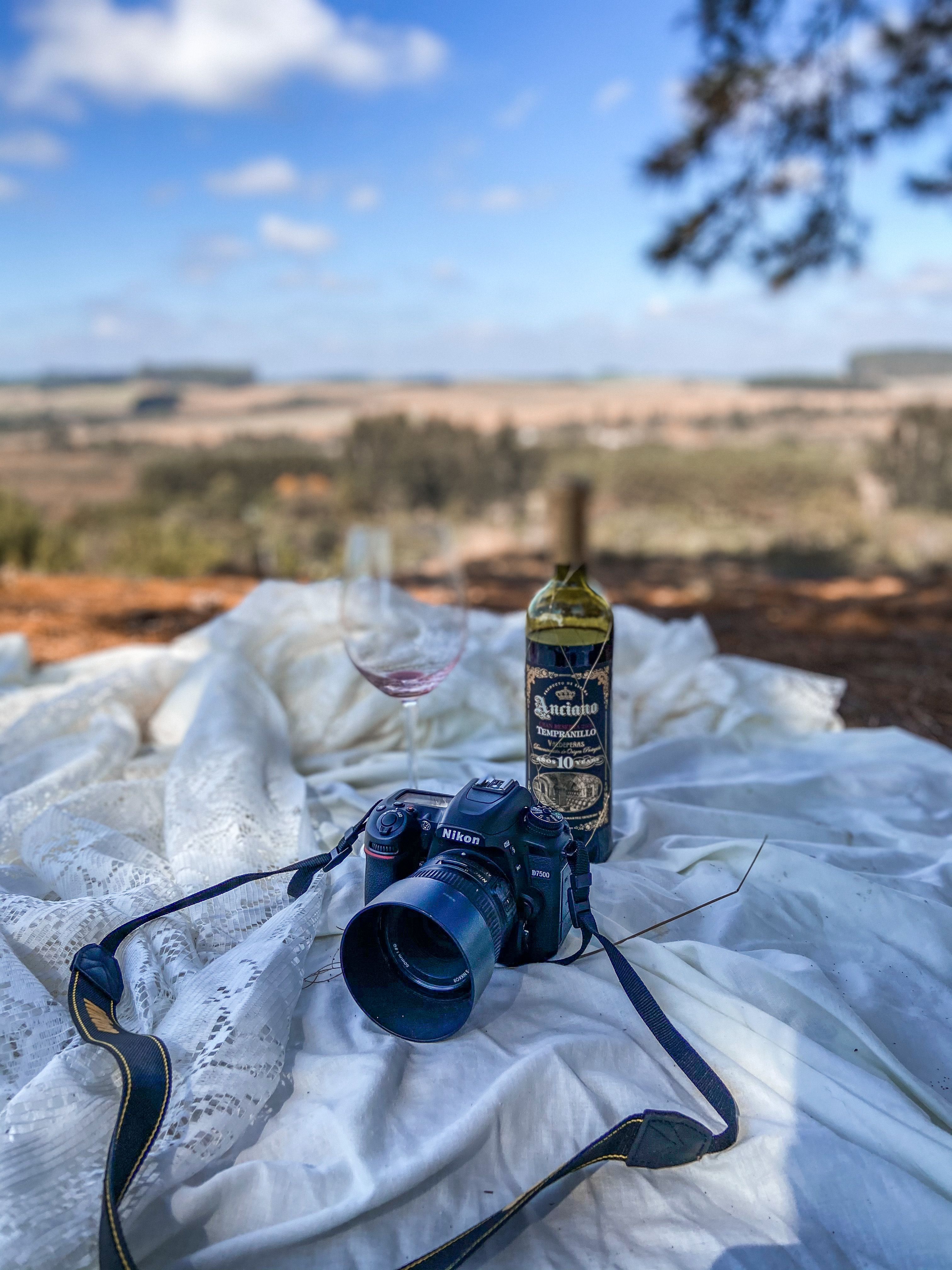 Still Life with Wine and Camera · Free Stock Photo
