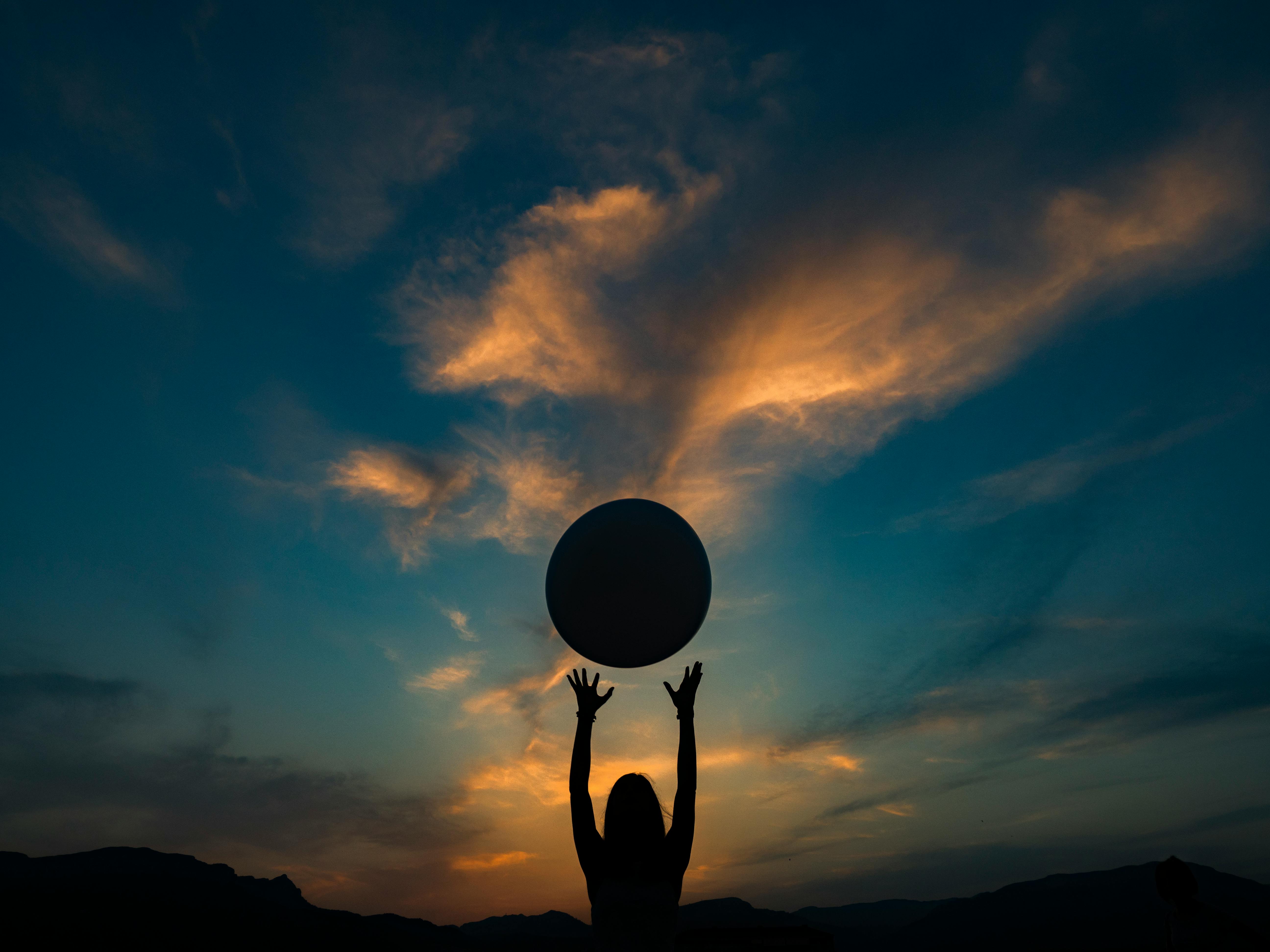 Person Lifting a Ball · Free Stock Photo