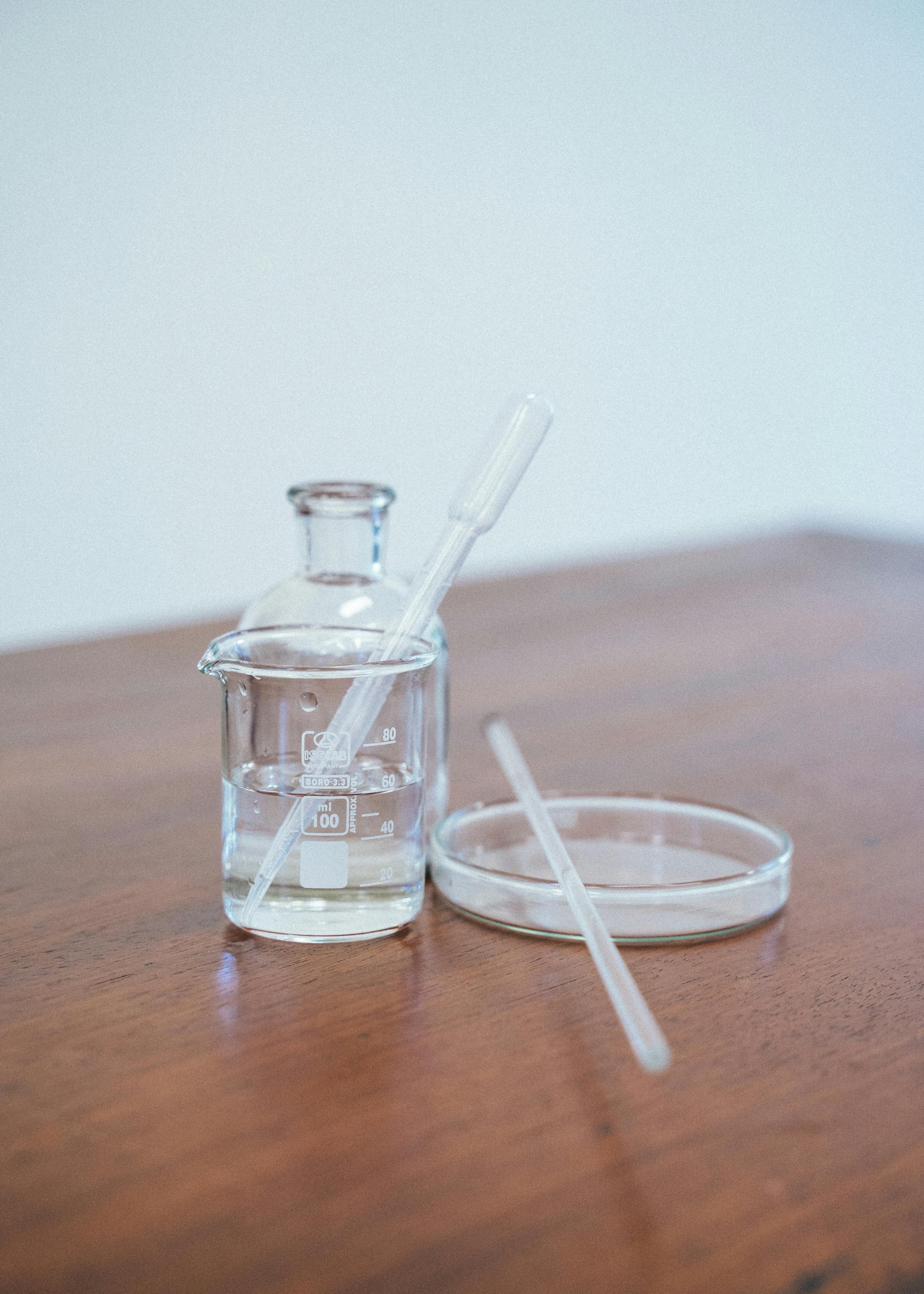 Beaker With Water and Dropper · Free Stock Photo