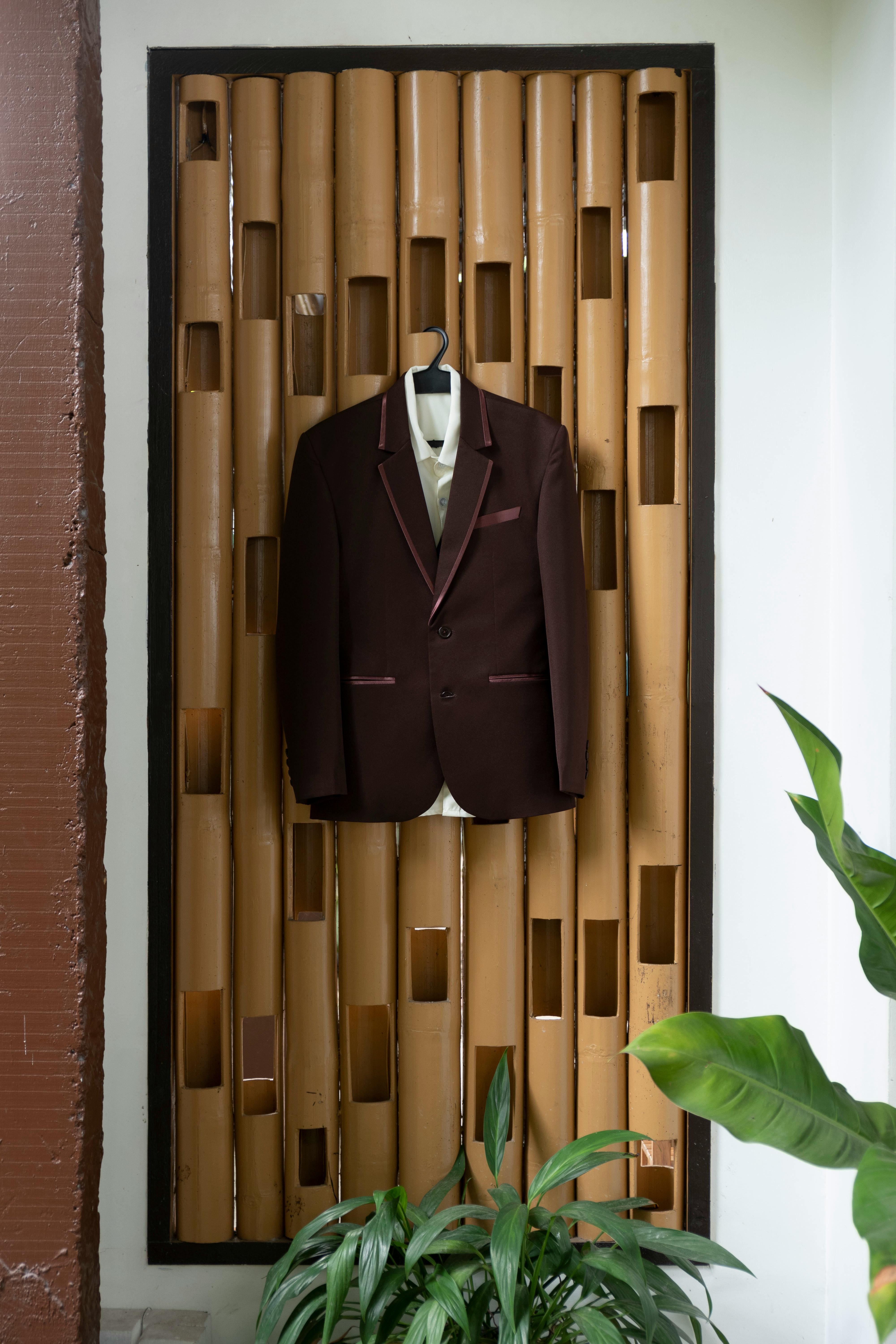 Suit Hanging on Bamboo Wall · Free Stock Photo
