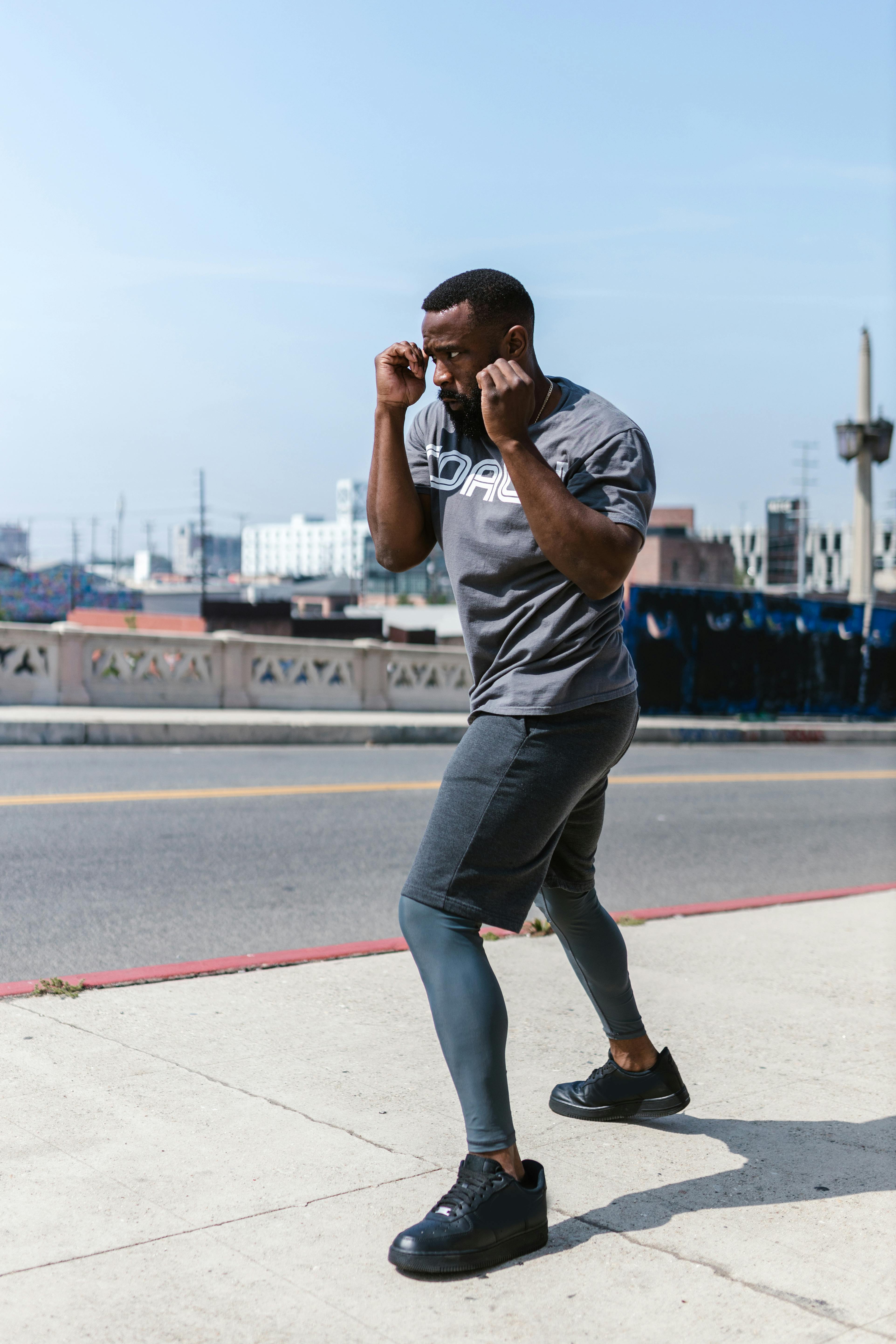 Man Doing Shadow Boxing on the Street · Free Stock Photo