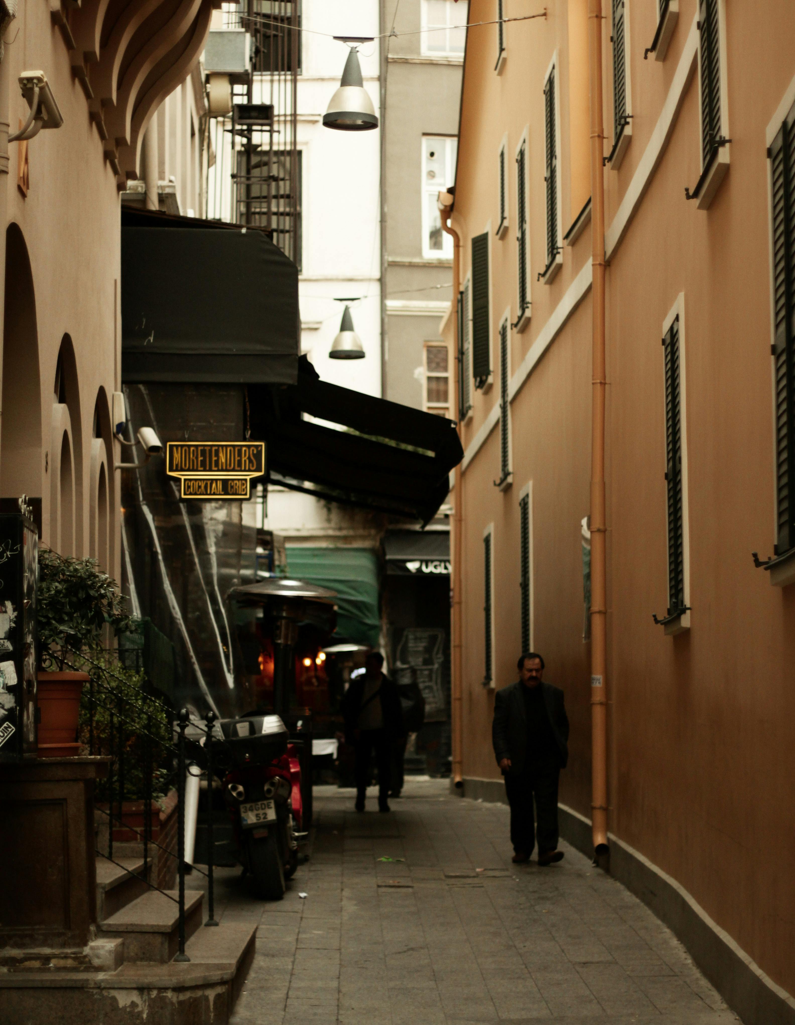 People Walking on an Alley Between Buildings · Free Stock Photo