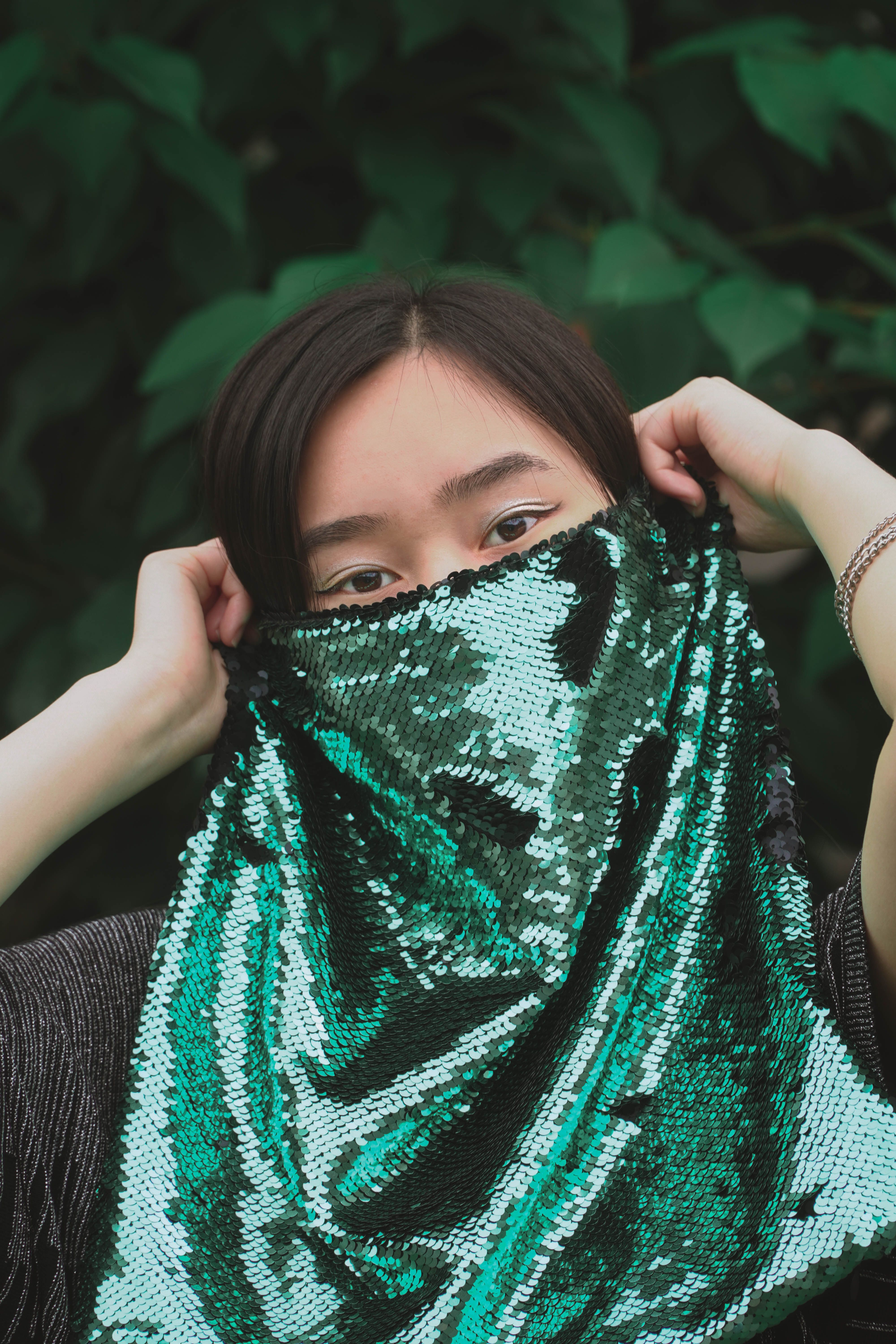 Photo of a Woman Covering Half of Her Face with a Cloth with Sequins ...