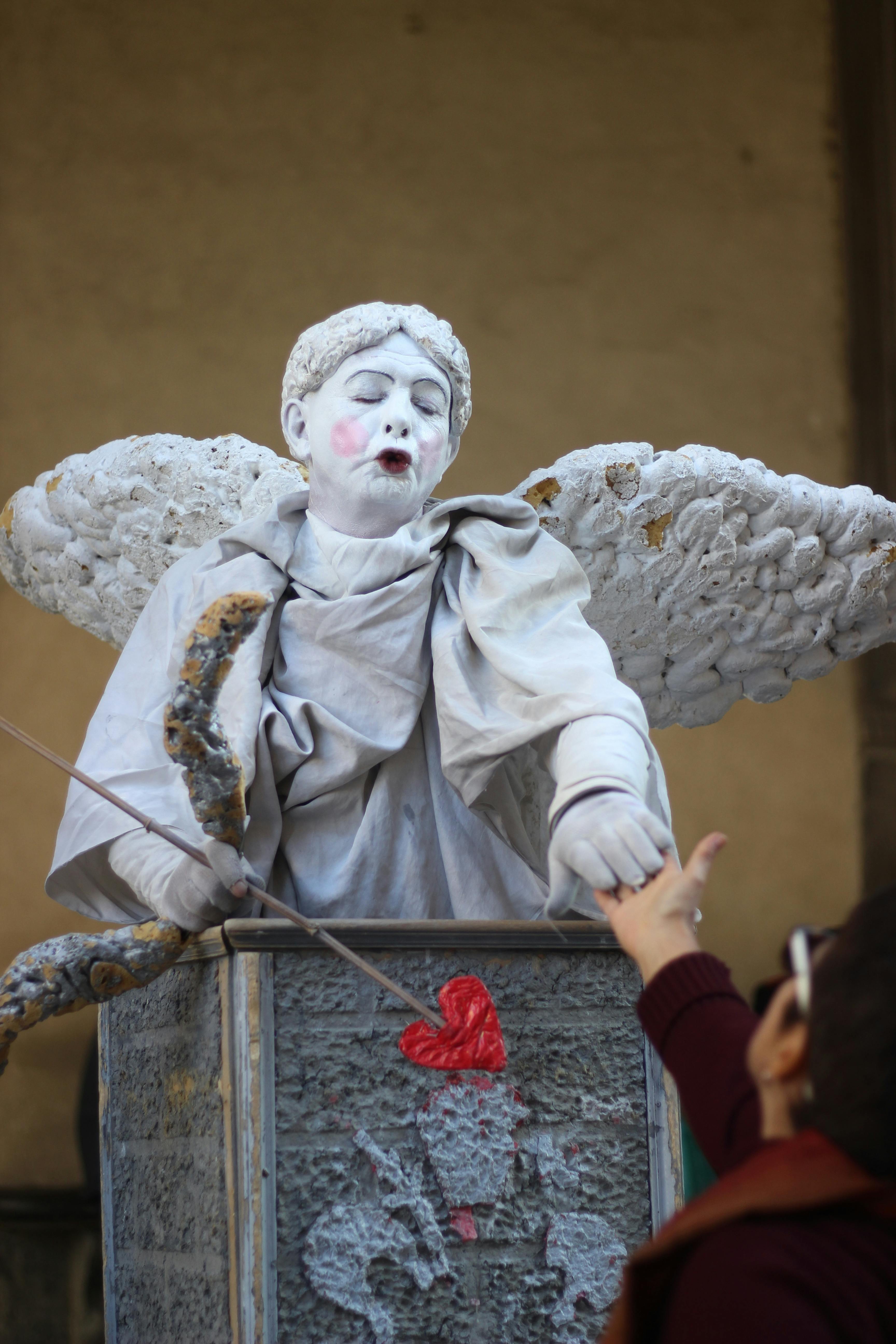 Person in Angel Costume Reaching out Towards Man · Free Stock Photo