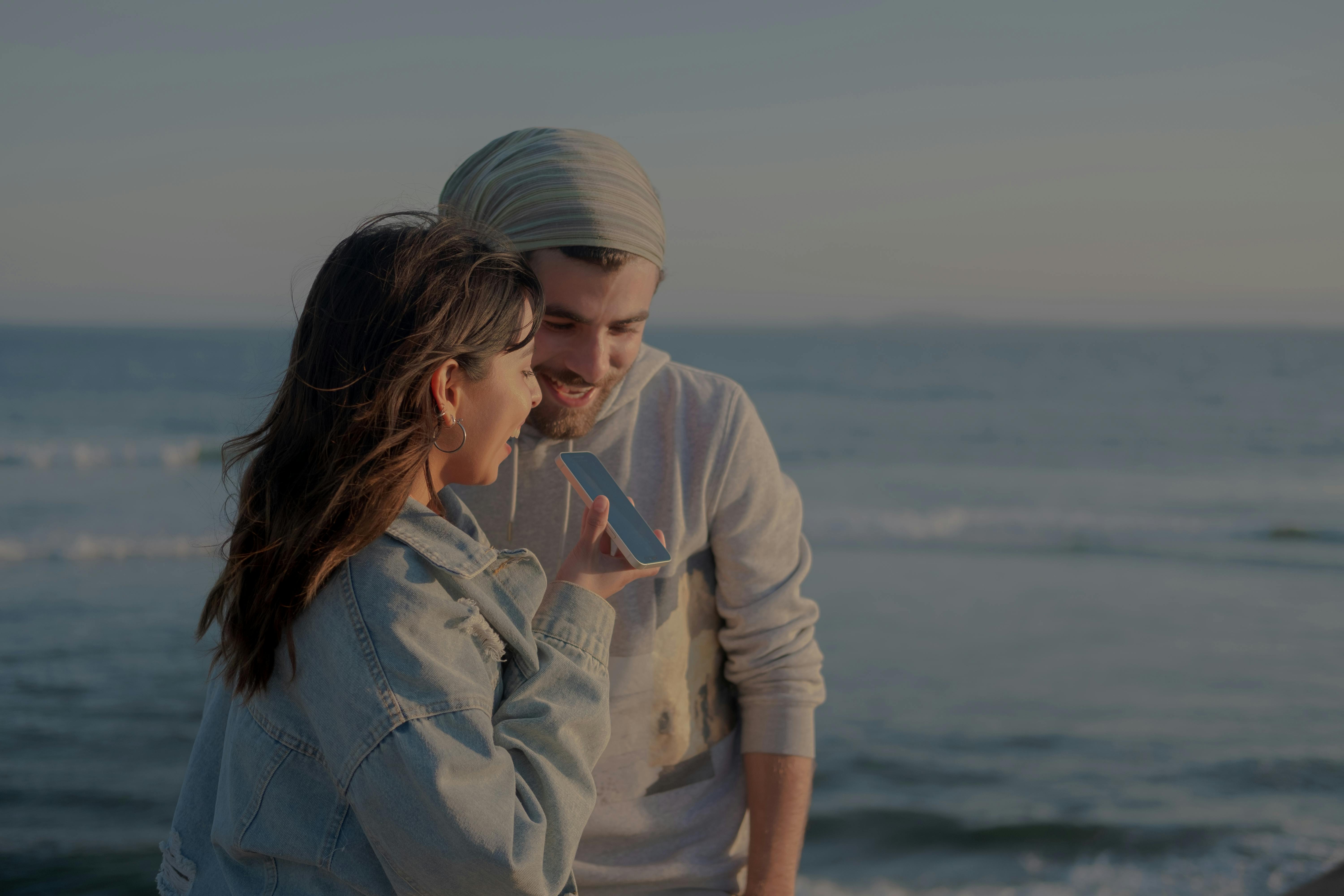 A Man and Woman Talking on the Phone Together · Free Stock Photo