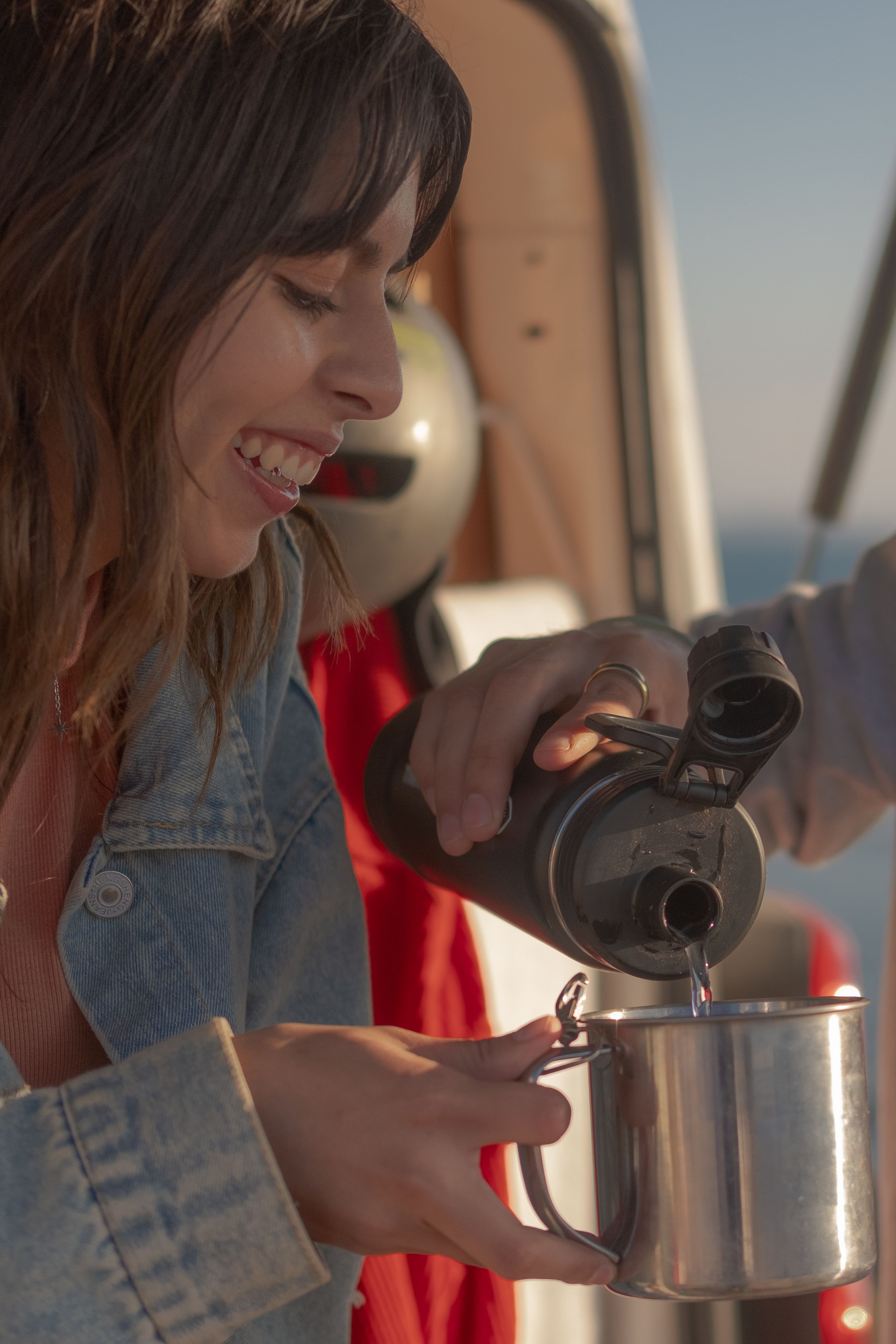 A Hand Pouring Water on a Stainless Steel Mug · Free Stock Photo