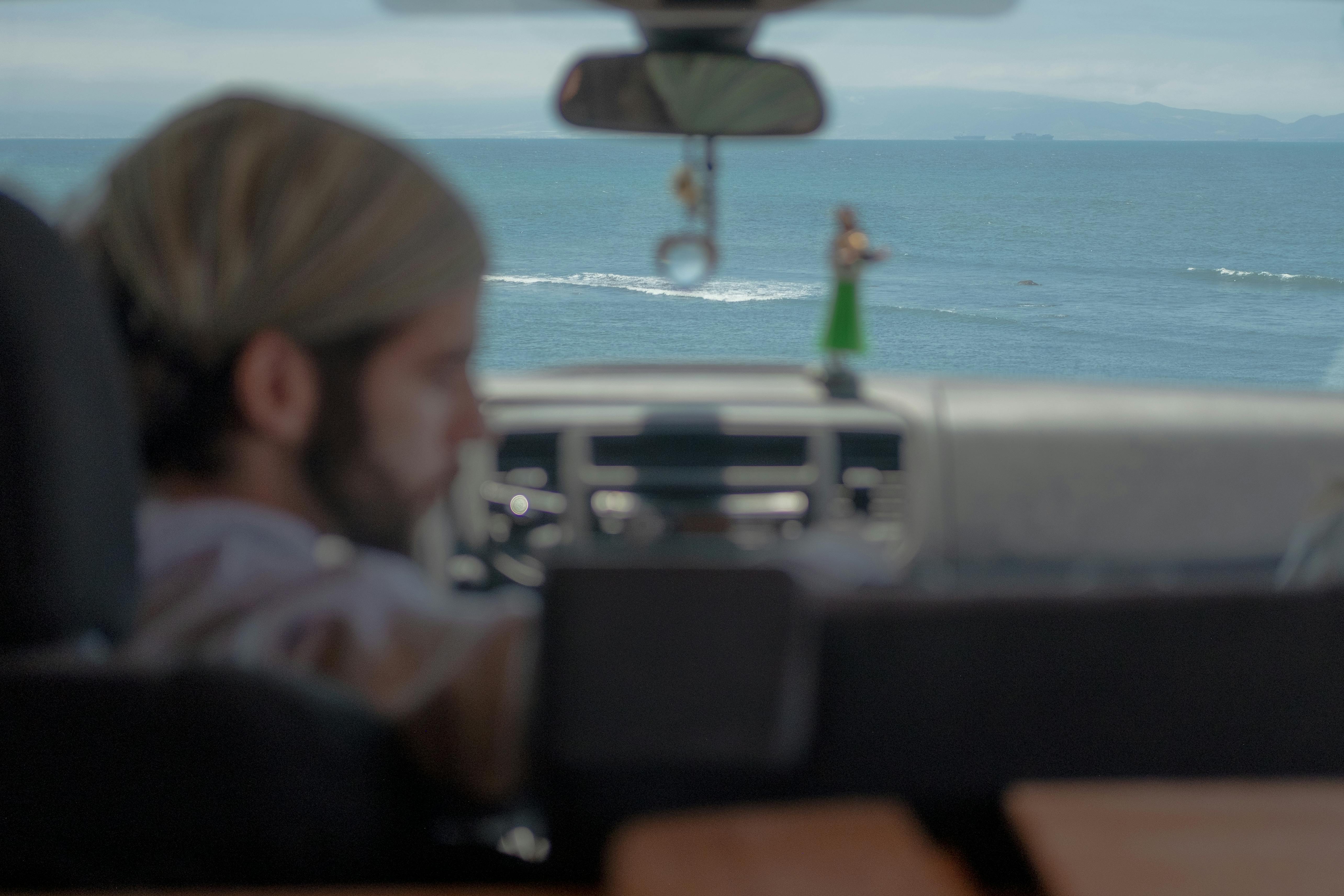 Man in Car by Sea · Free Stock Photo