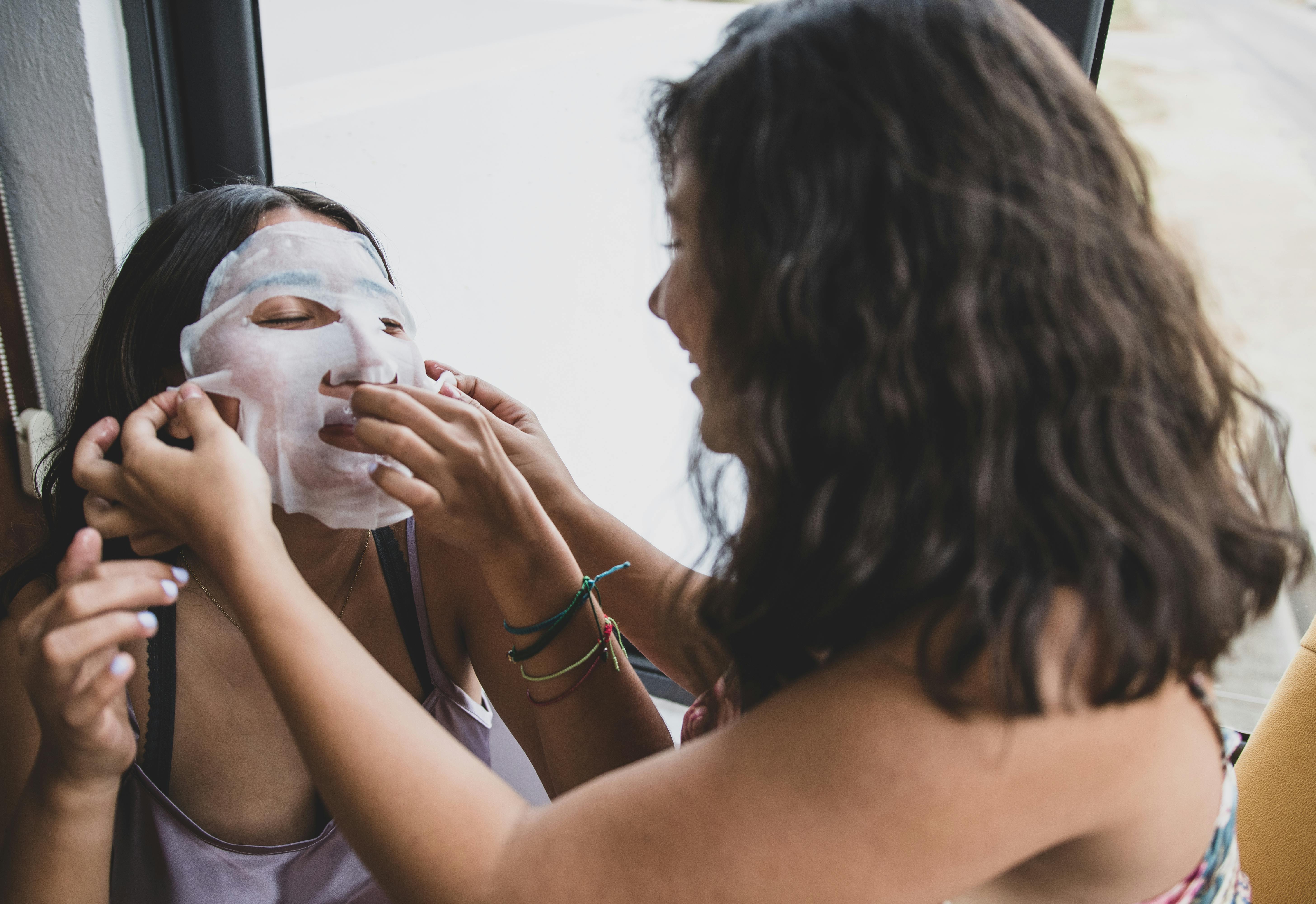 Woman Putting a Facial Mask on Another Woman's Face · Free Stock Photo