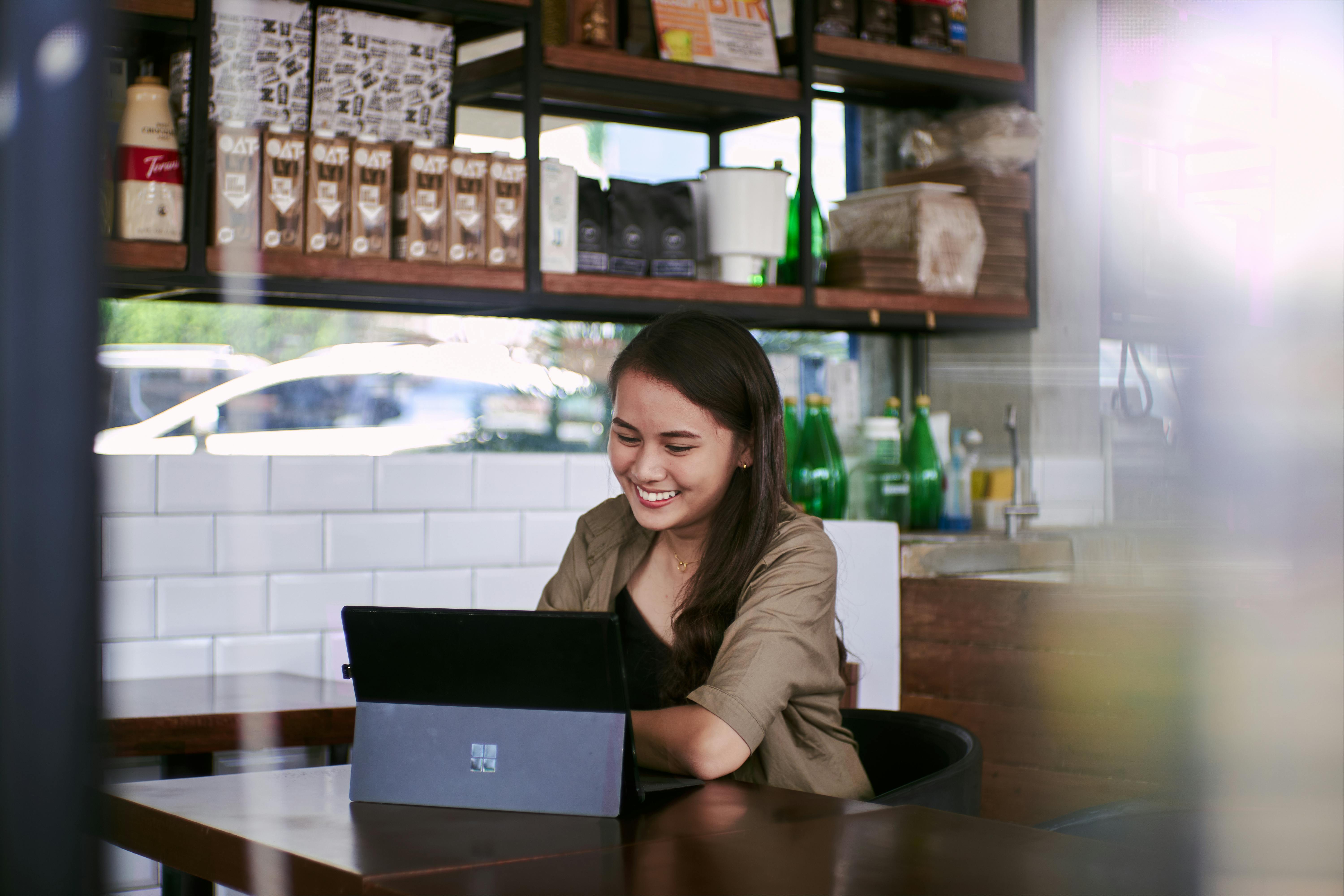 Man Sitting by the Table Using Computer Laptop · Free Stock Photo