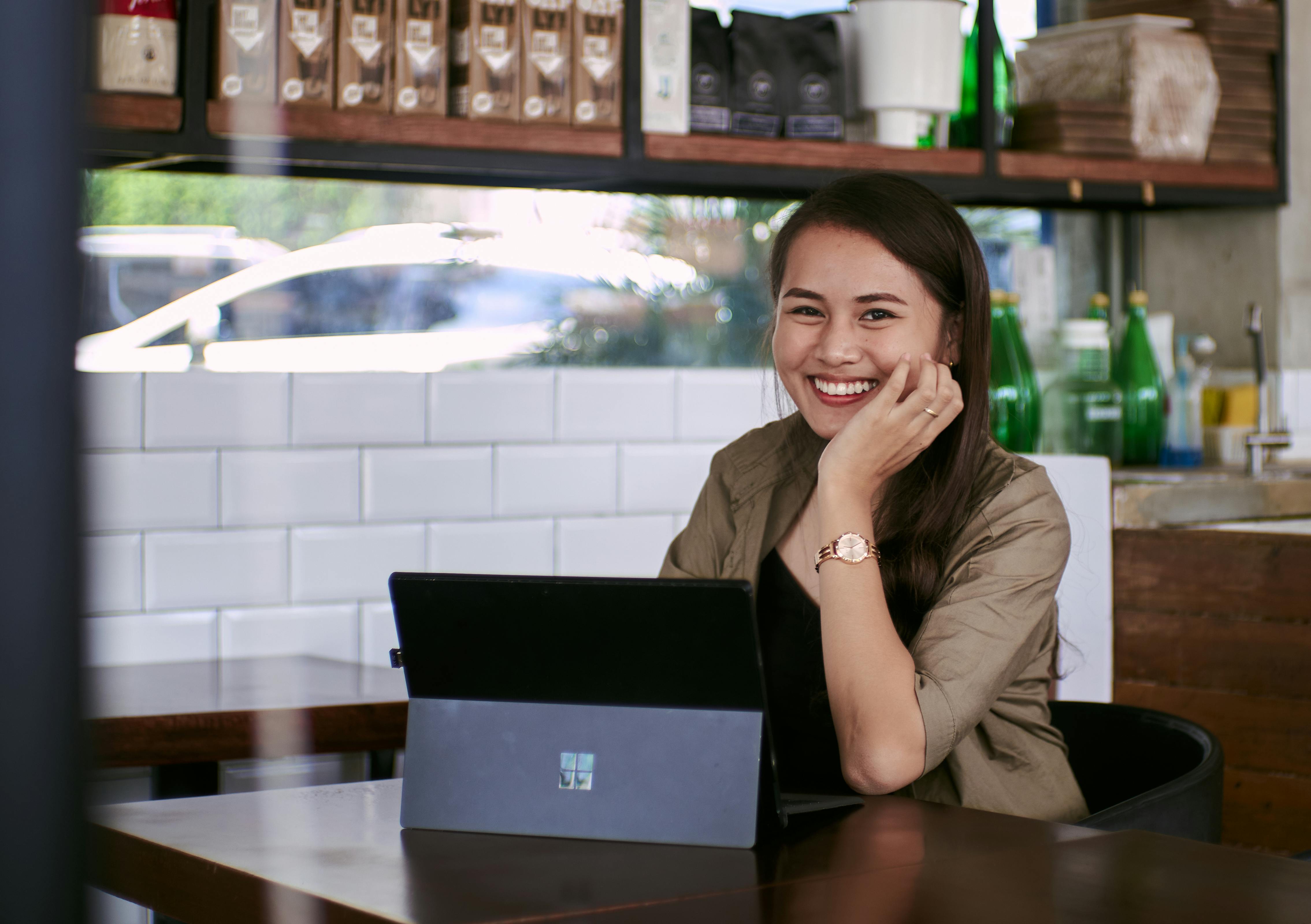 Man Sitting by the Table Using Computer Laptop · Free Stock Photo