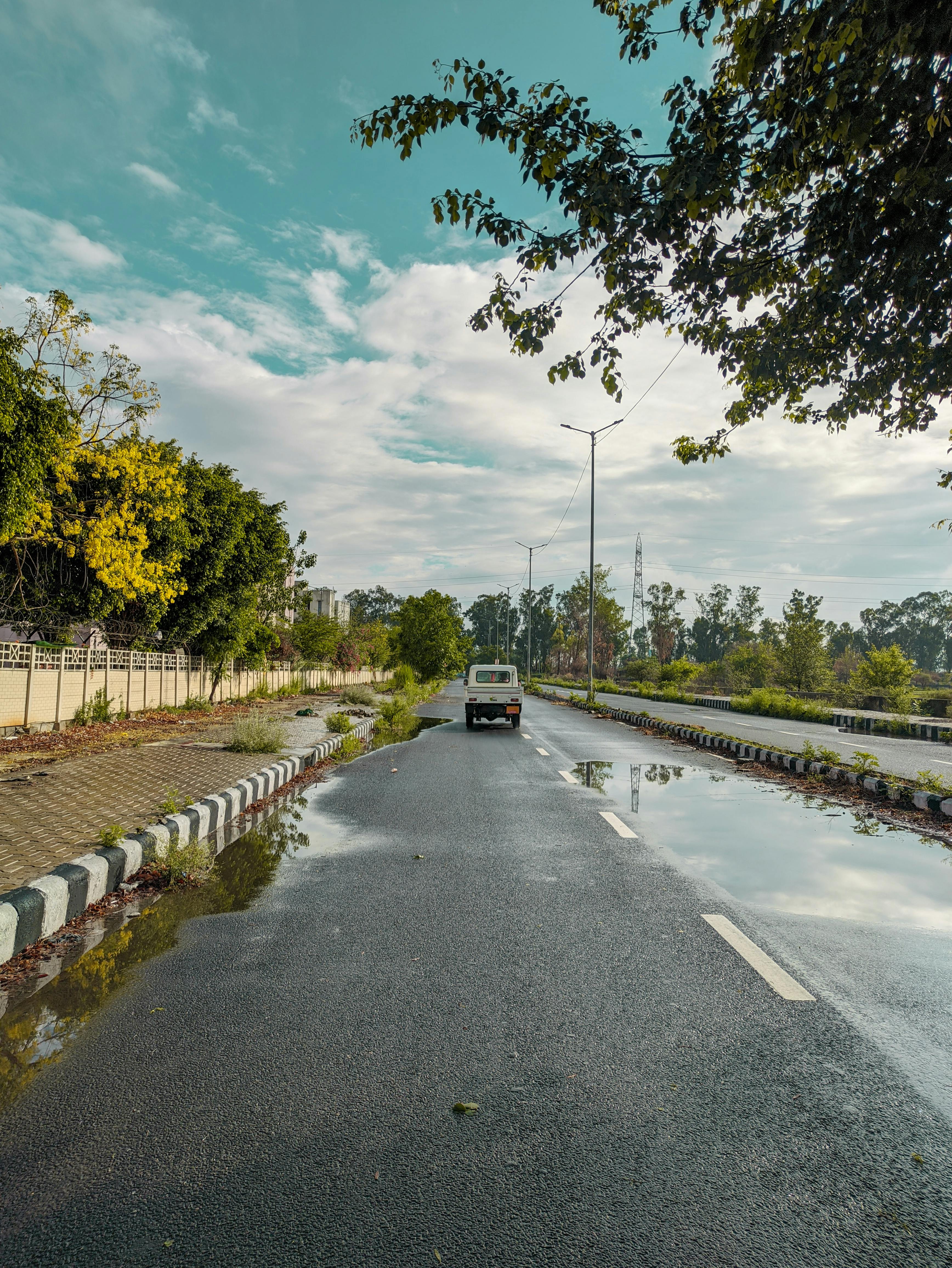 Back View of a Car on the Wet Road · Free Stock Photo