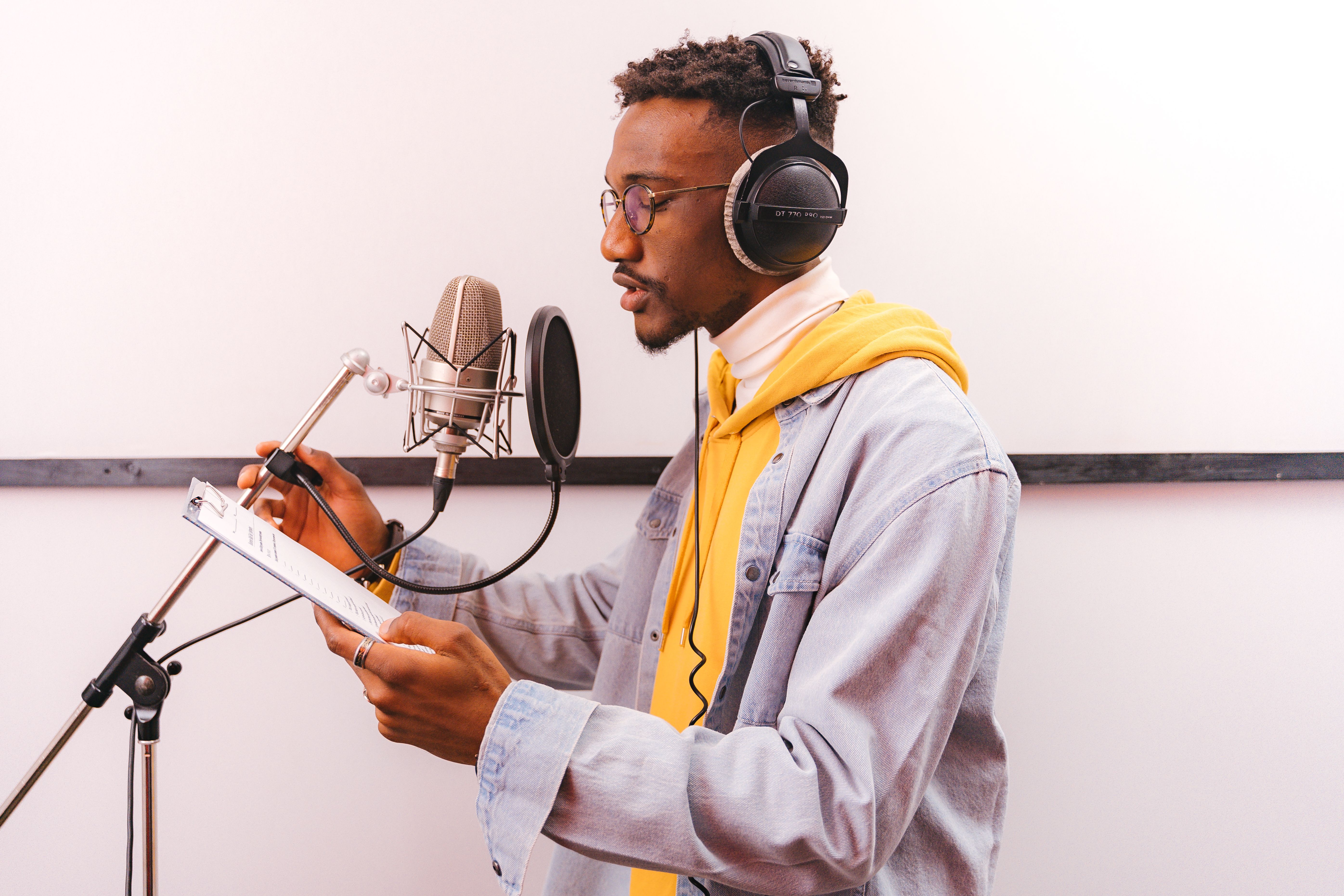 A Man Holding the Microphone While Singing · Free Stock Photo
