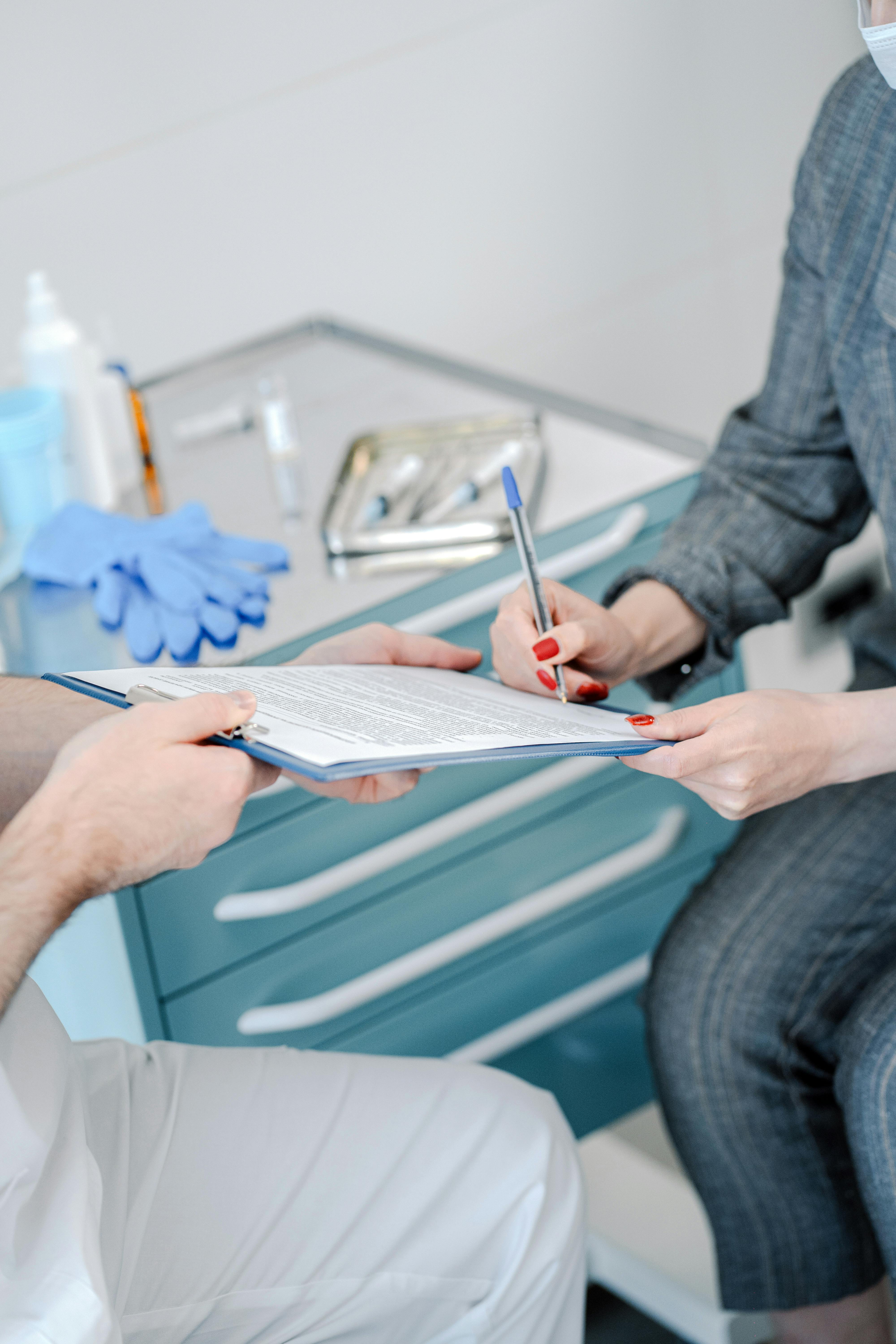 Patient Signing Agreement in Doctor Office · Free Stock Photo