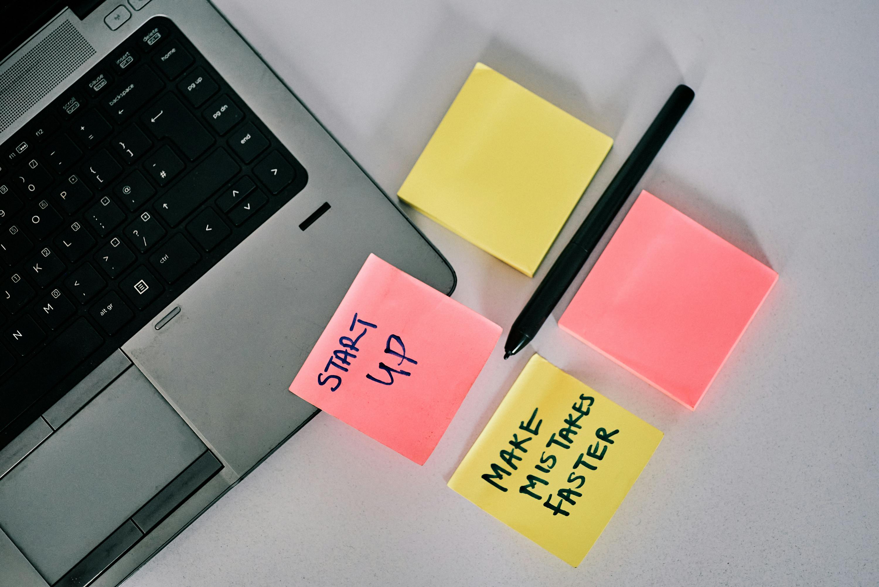 Person Holding a Laptop with Sticky Notes · Free Stock Photo