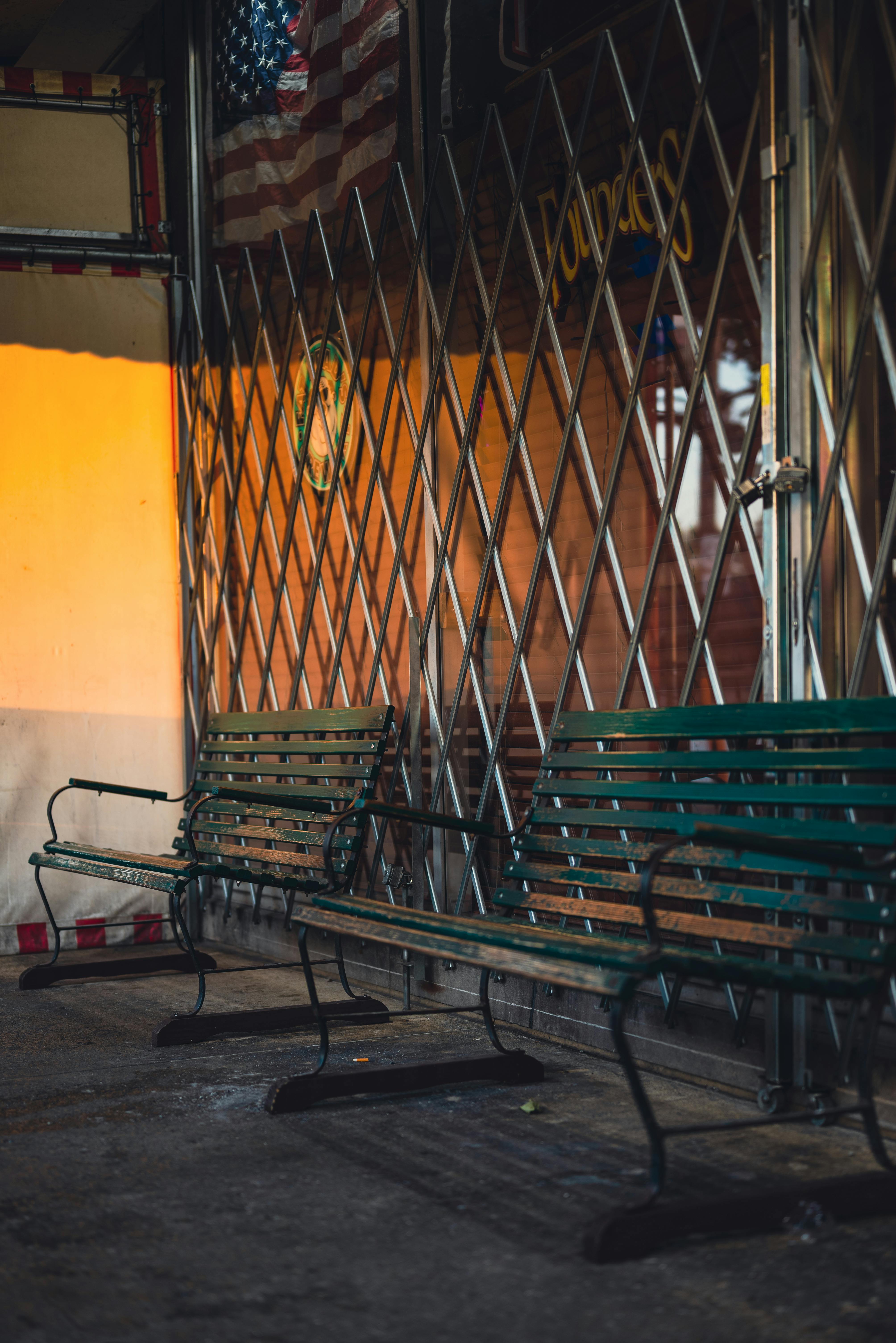 Empty Benches Standing Before Barred Shop · Free Stock Photo