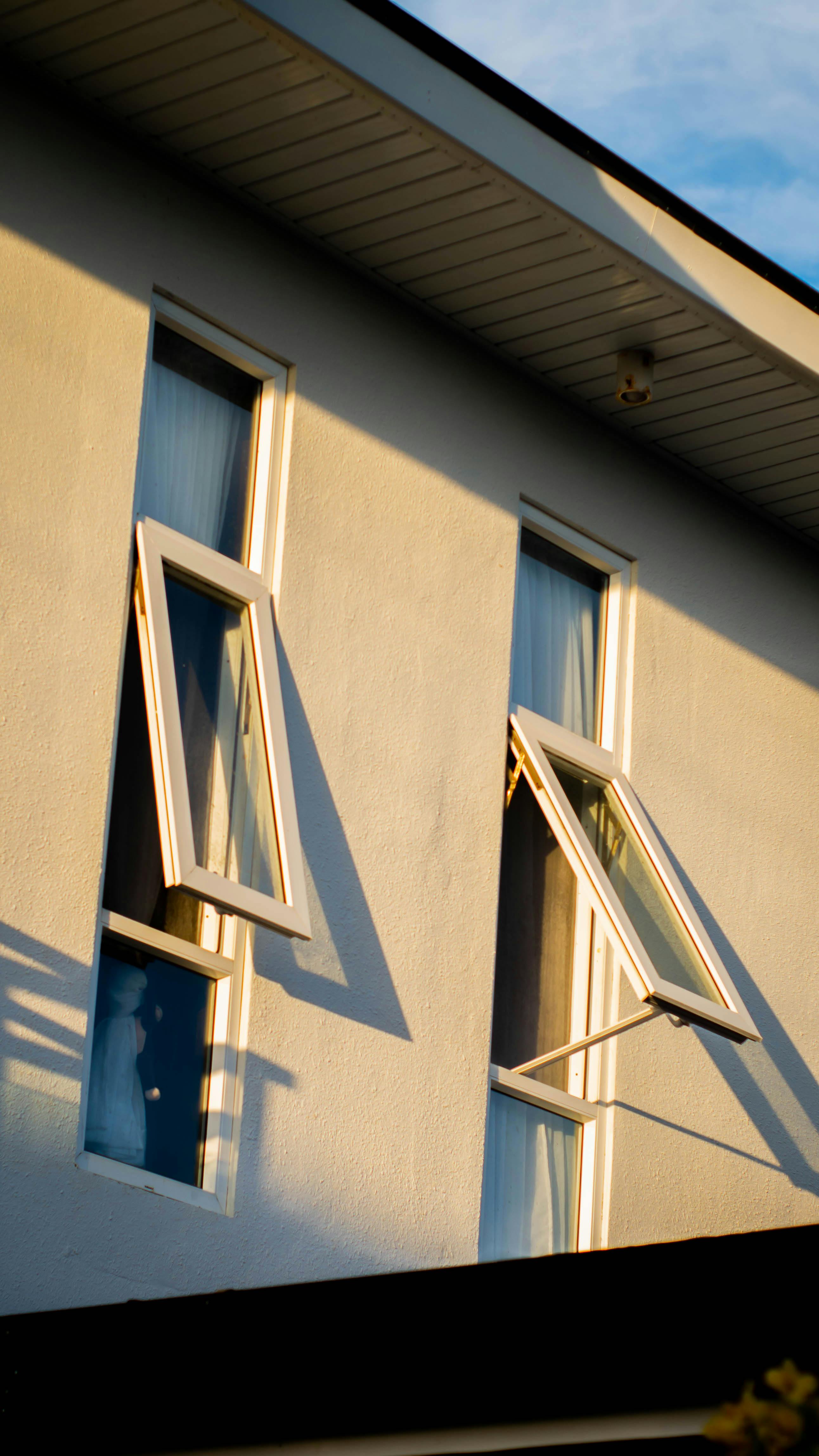 Low-Angle Shot of Open Windows of a Building · Free Stock Photo
