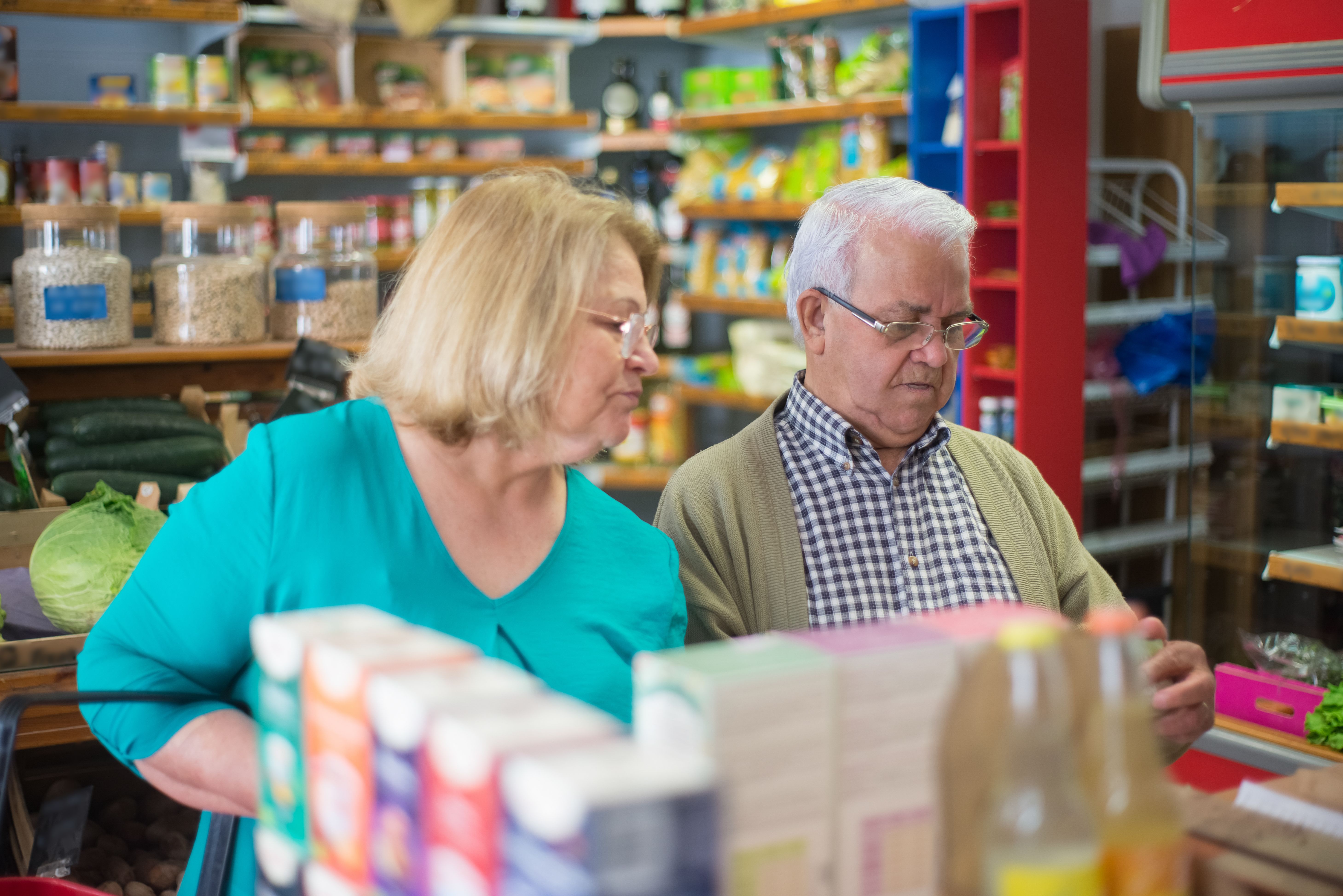 Smiling Elderly Man Buying Groceries · Free Stock Photo