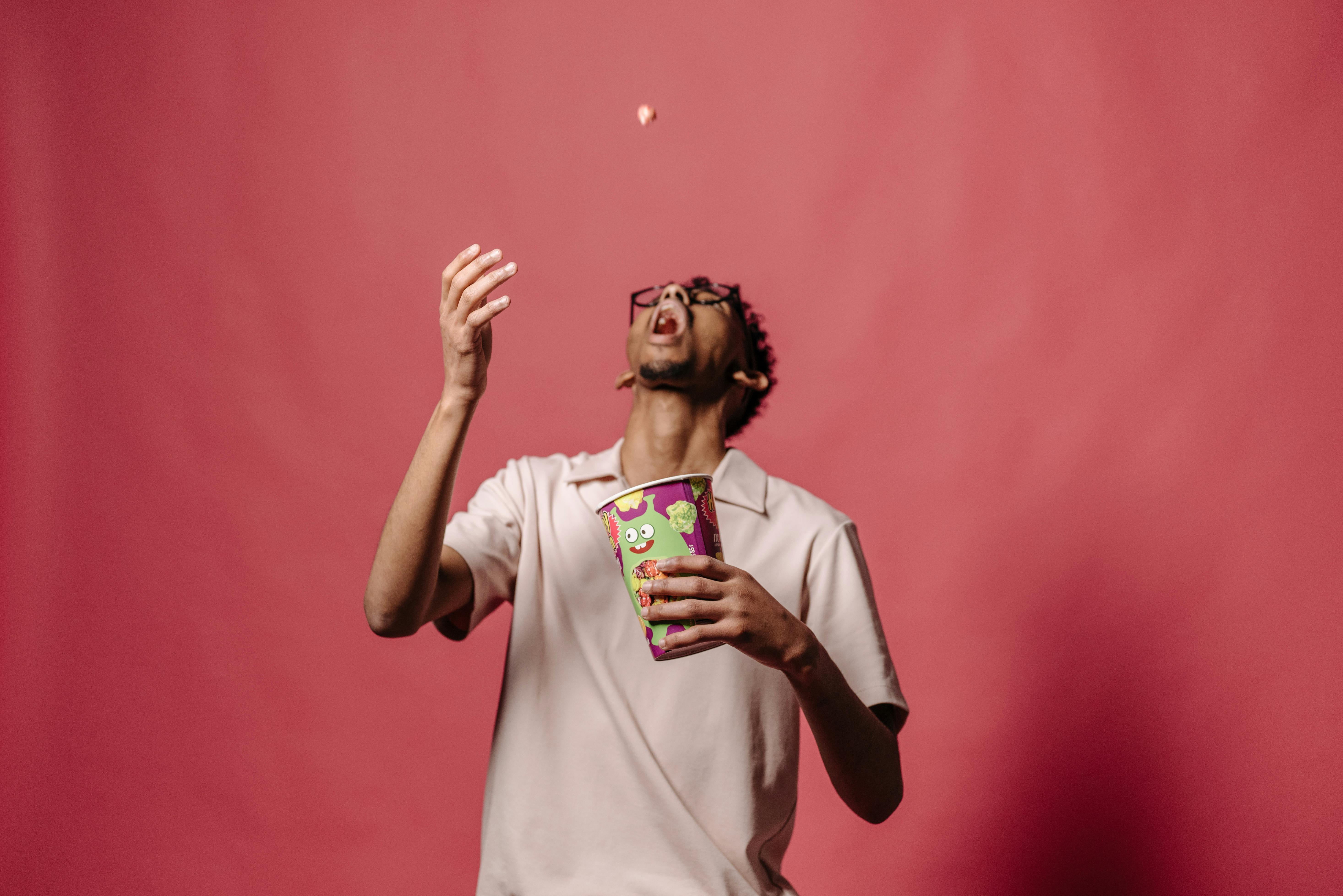 Photo of a Man Throwing Food into his Mouth · Free Stock Photo