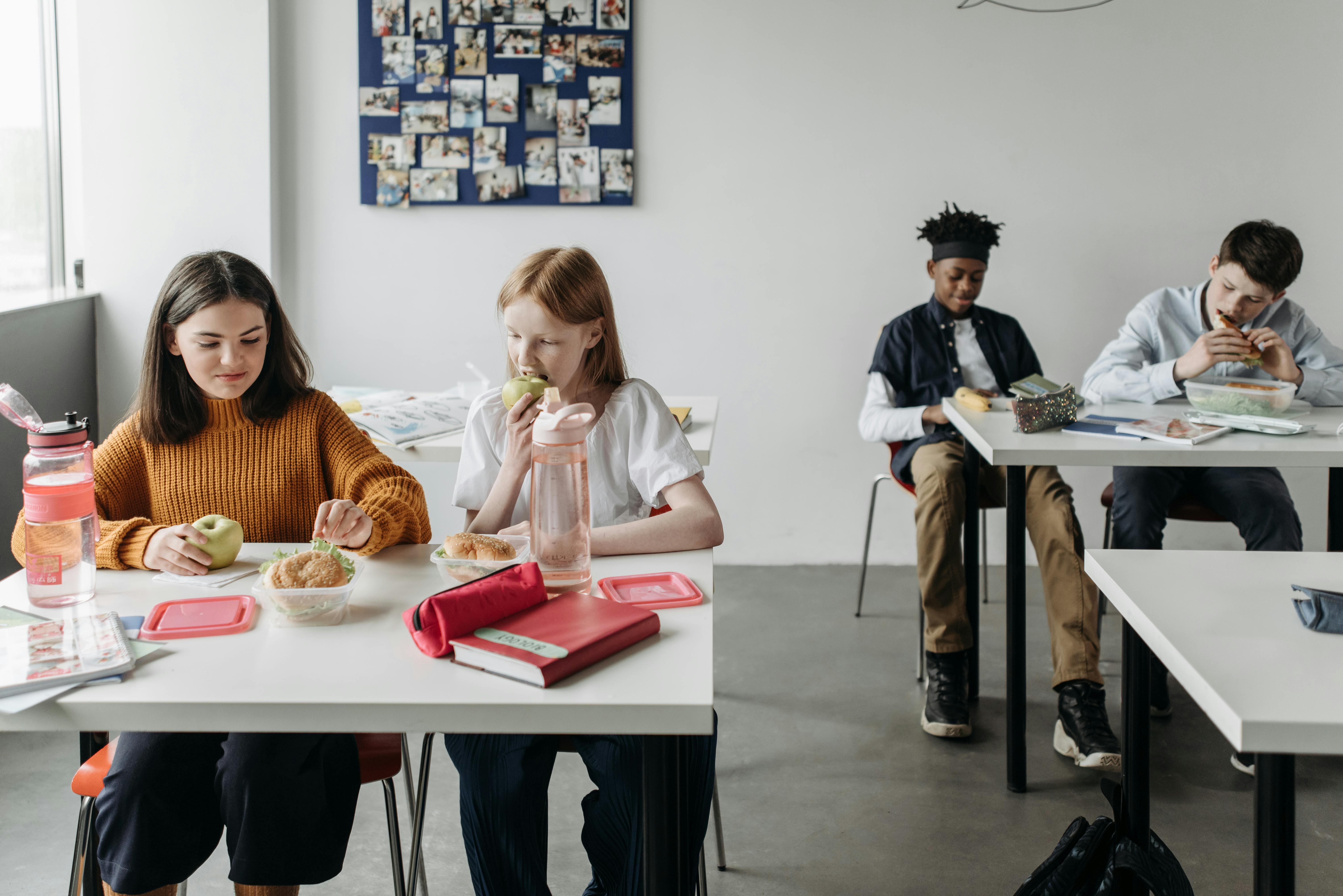 A Girls and Boys Eating in the Classroom · Free Stock Photo