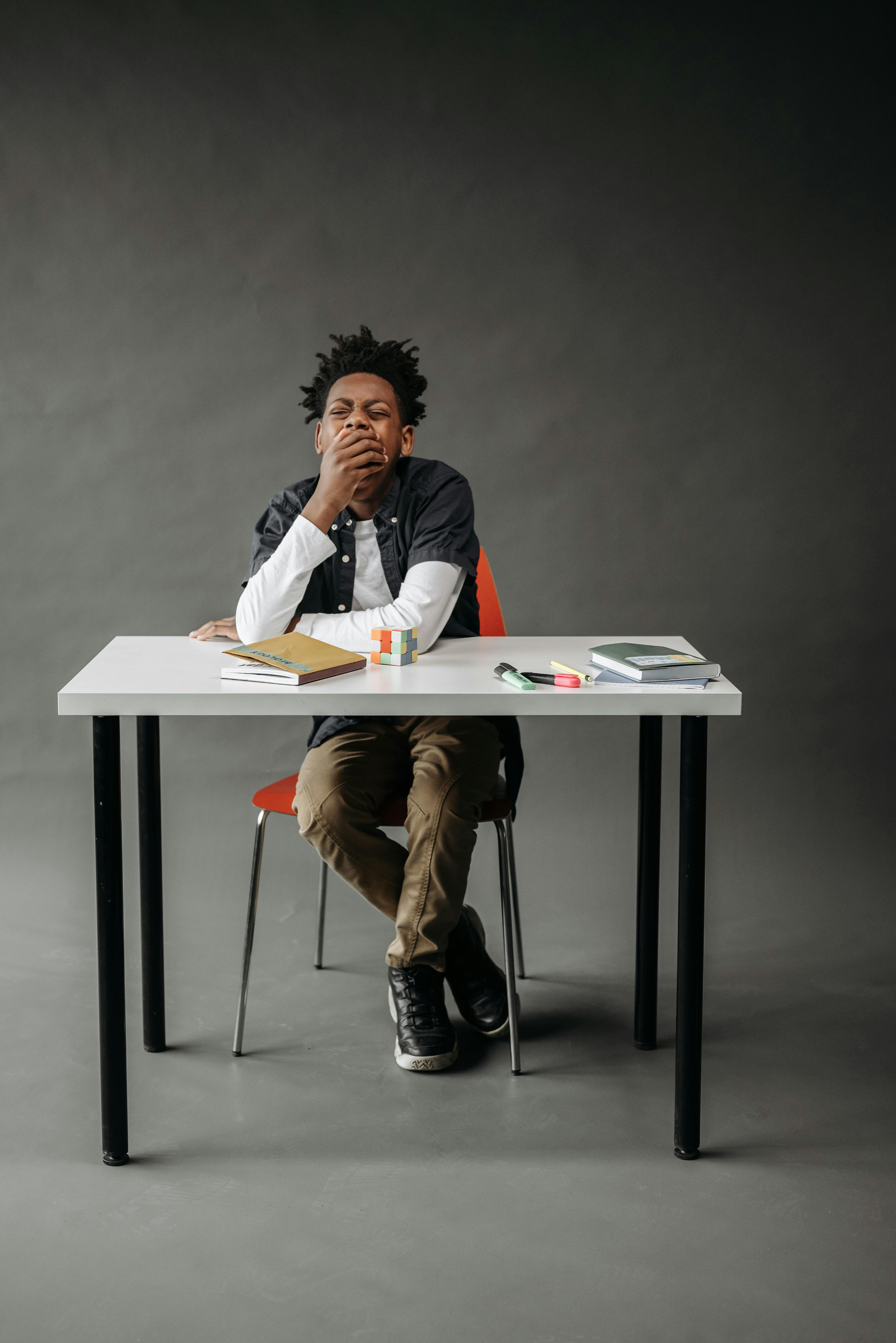 A Boy Sitting at the Table · Free Stock Photo