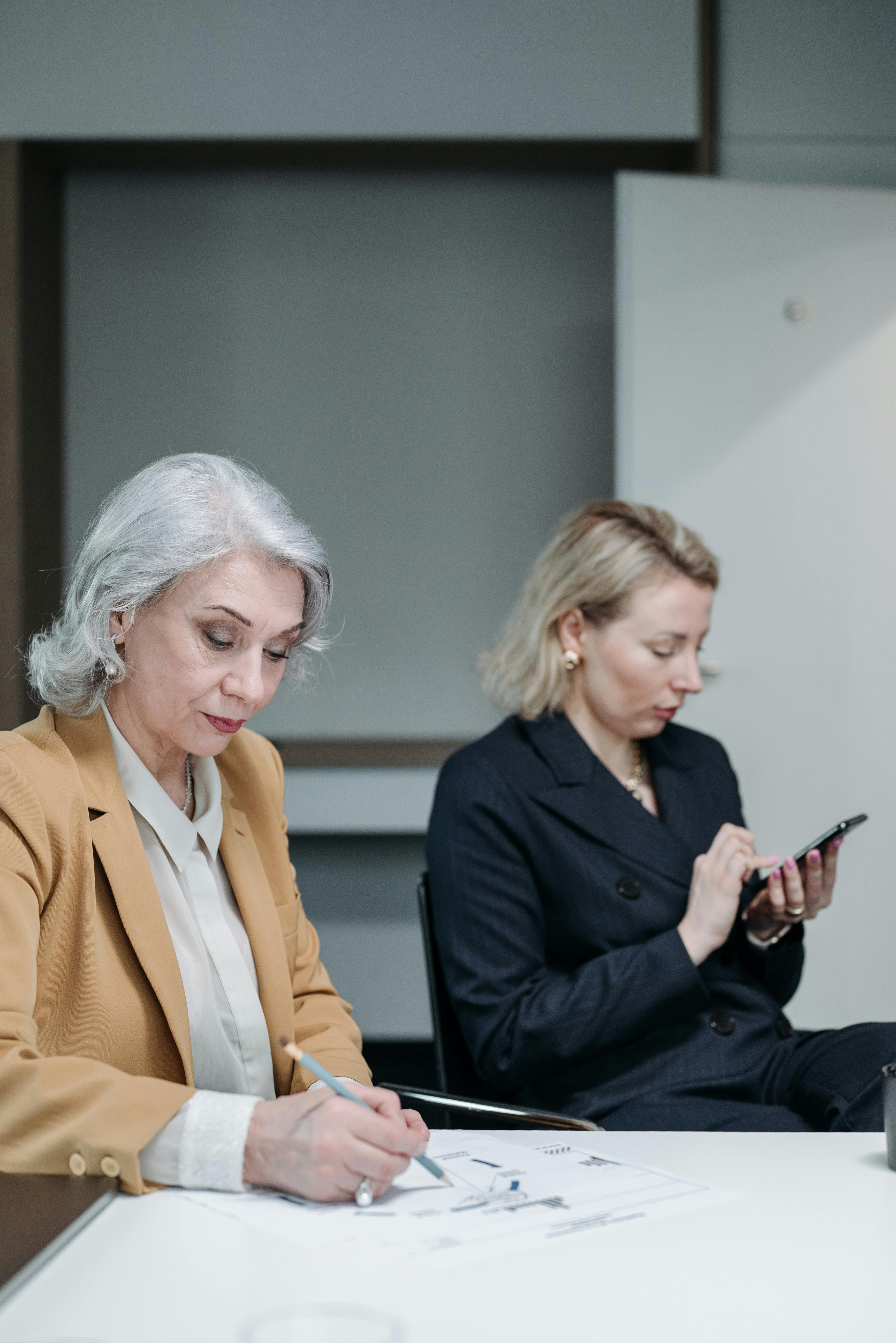 Women Working Side by Side at an Office · Free Stock Photo