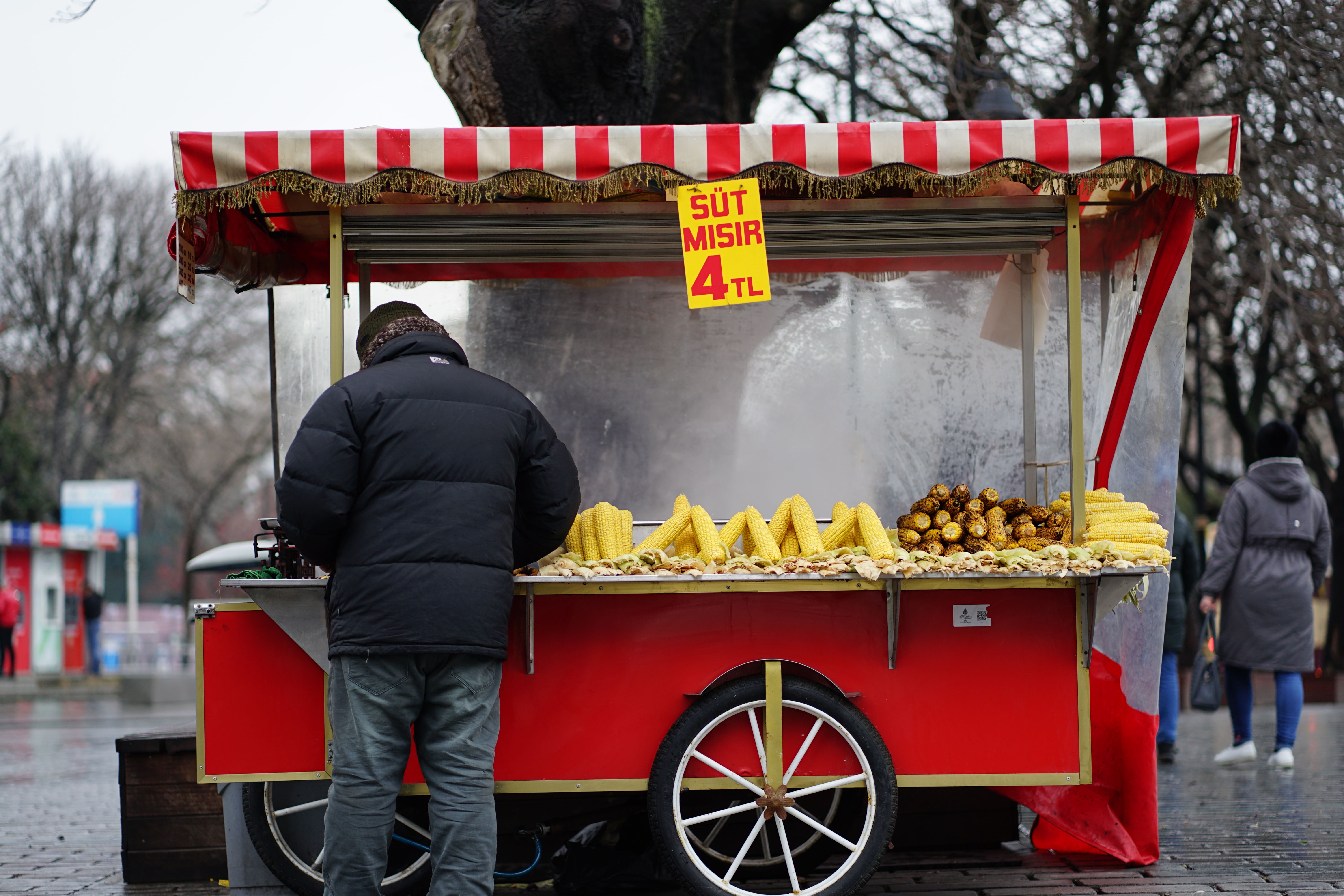 Man Selling Snack at Street Stall · Free Stock Photo