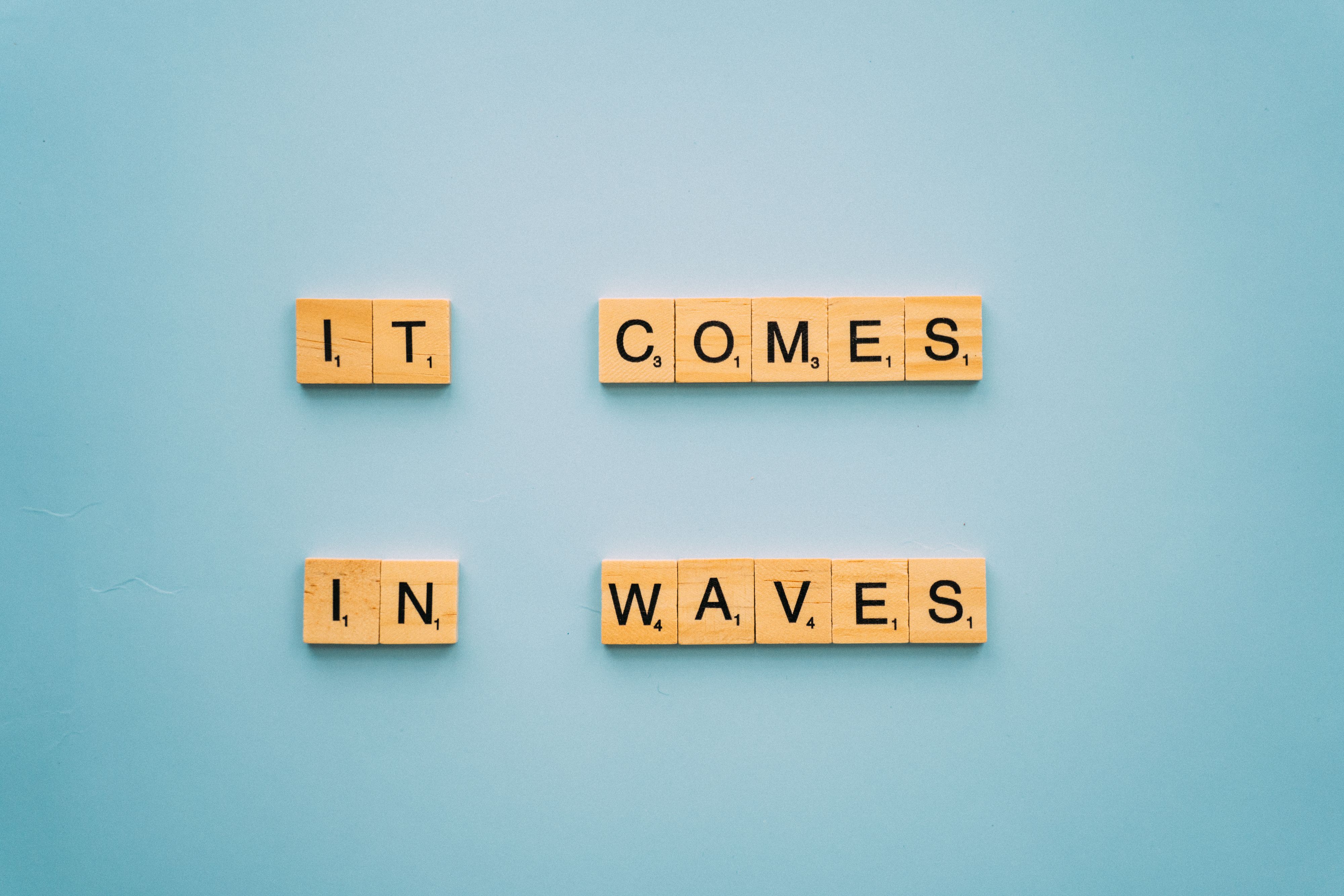Wooden Scrabble Tiles on Blue Background · Free Stock Photo