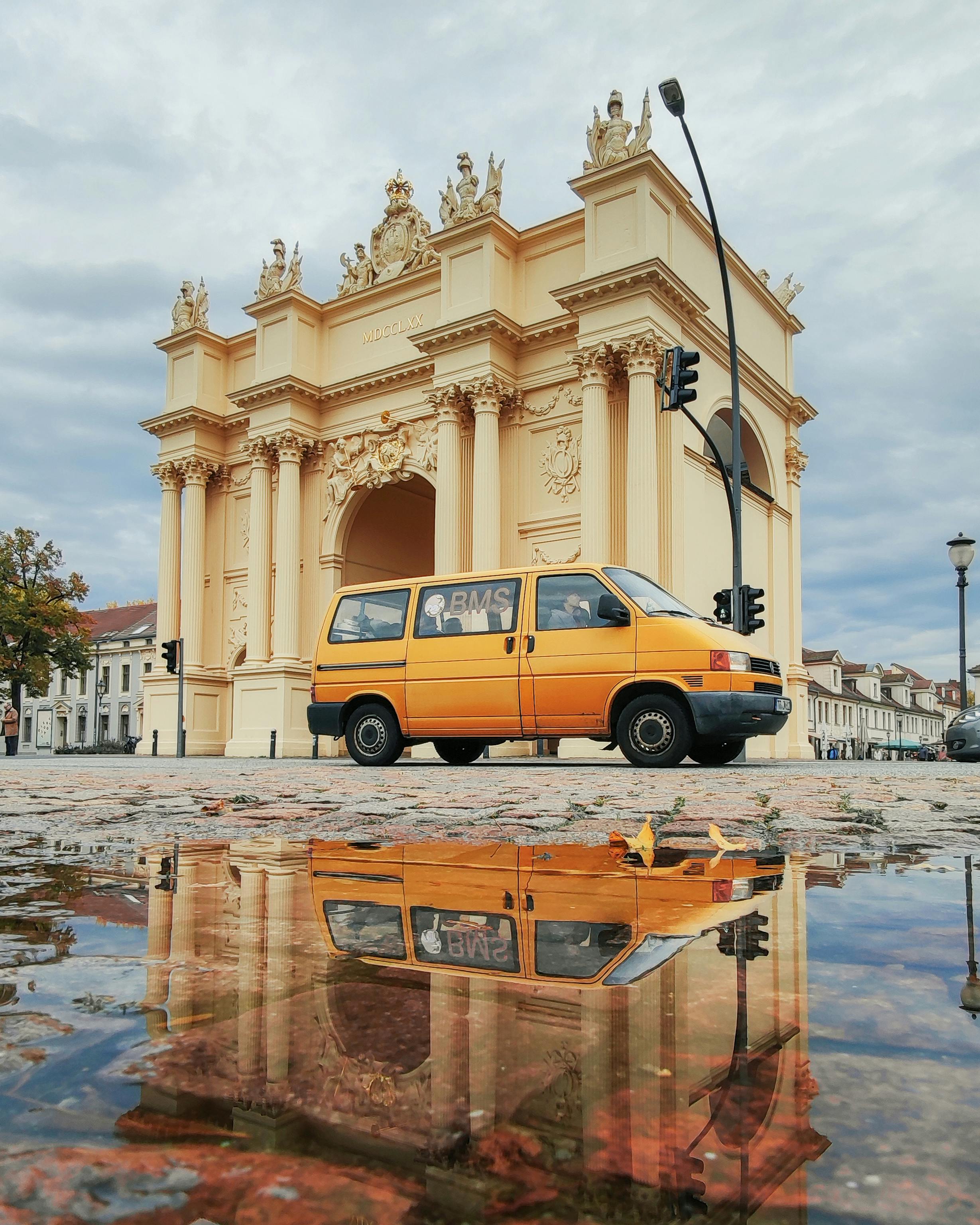 A Yellow Van Reflecting on Water · Free Stock Photo
