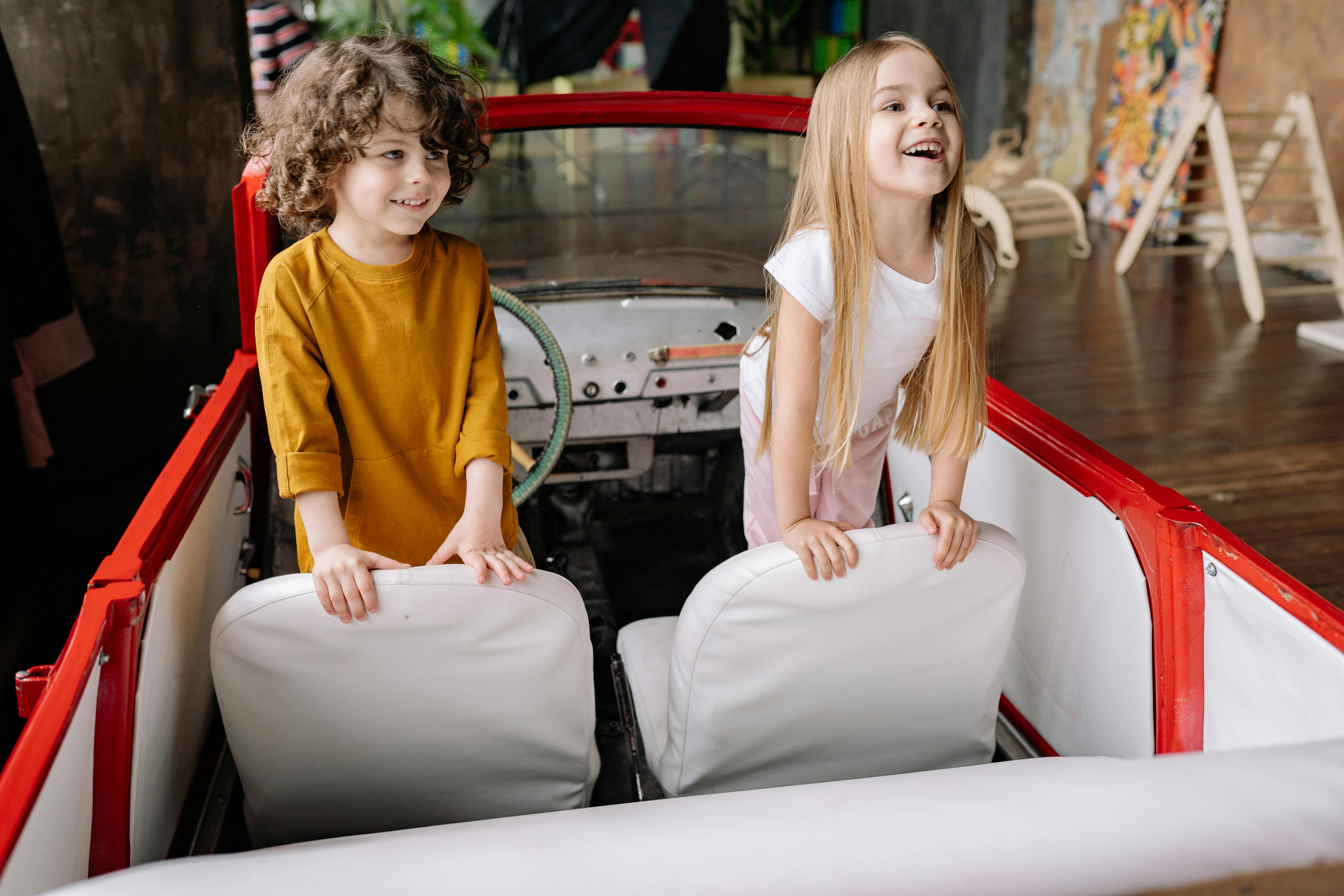 Kids Playing in Car in Photo Studio · Free Stock Photo