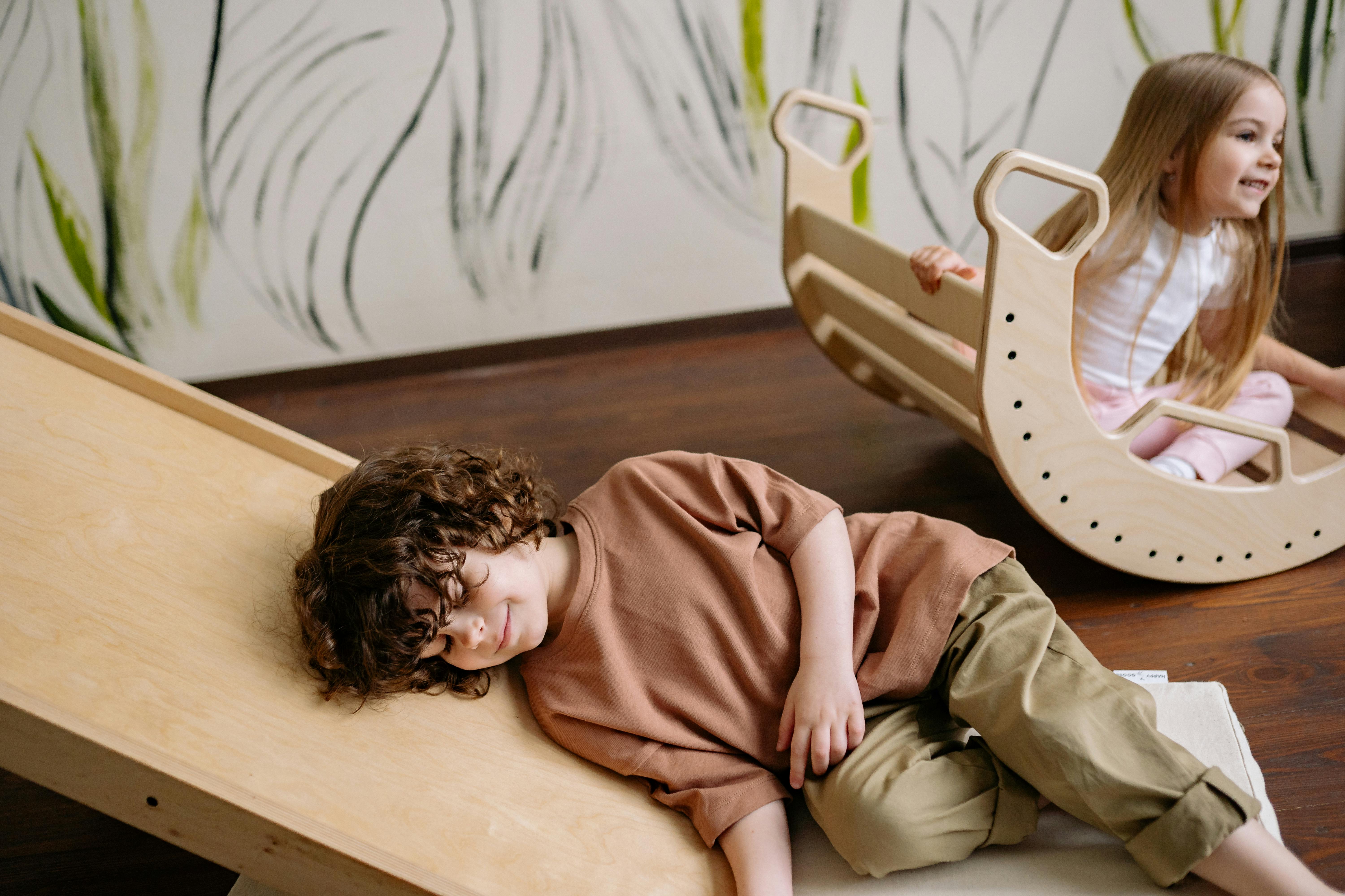 Young Boy Sleeping on a Slide · Free Stock Photo