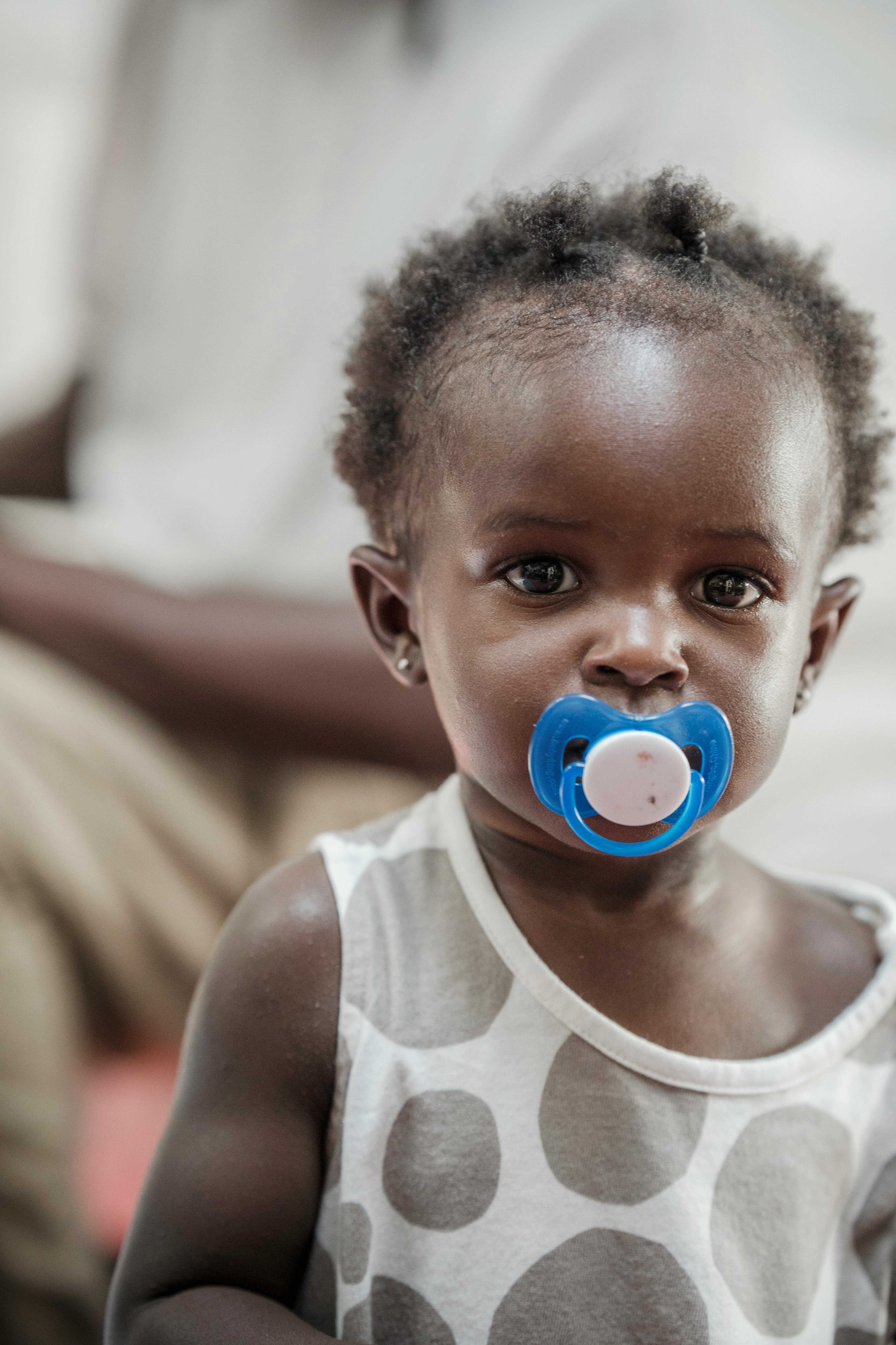 Close Up Photo of a Little Girl with a Pacifier · Free Stock Photo