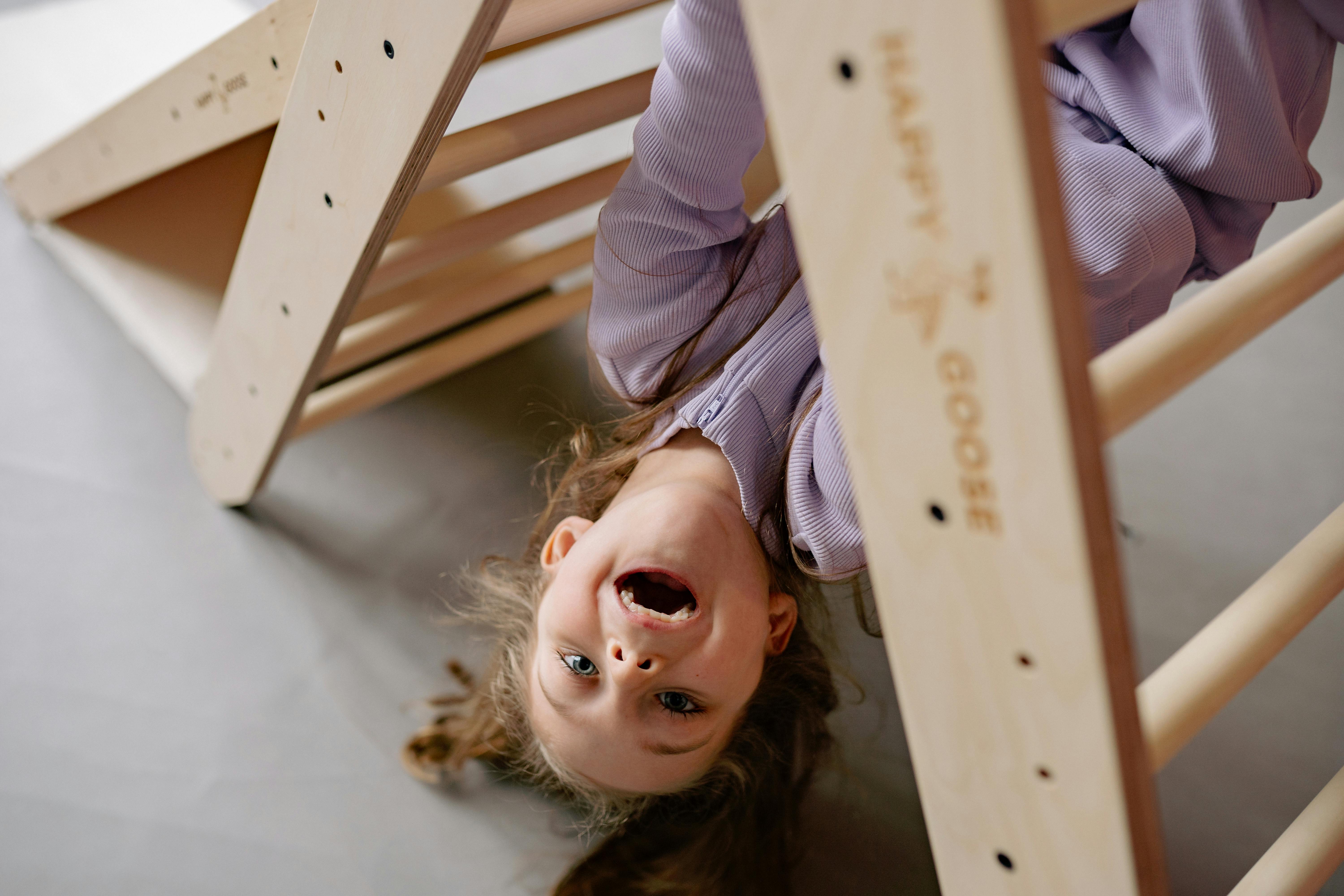 Happy Child on a Wooden Toy Ladder · Free Stock Photo