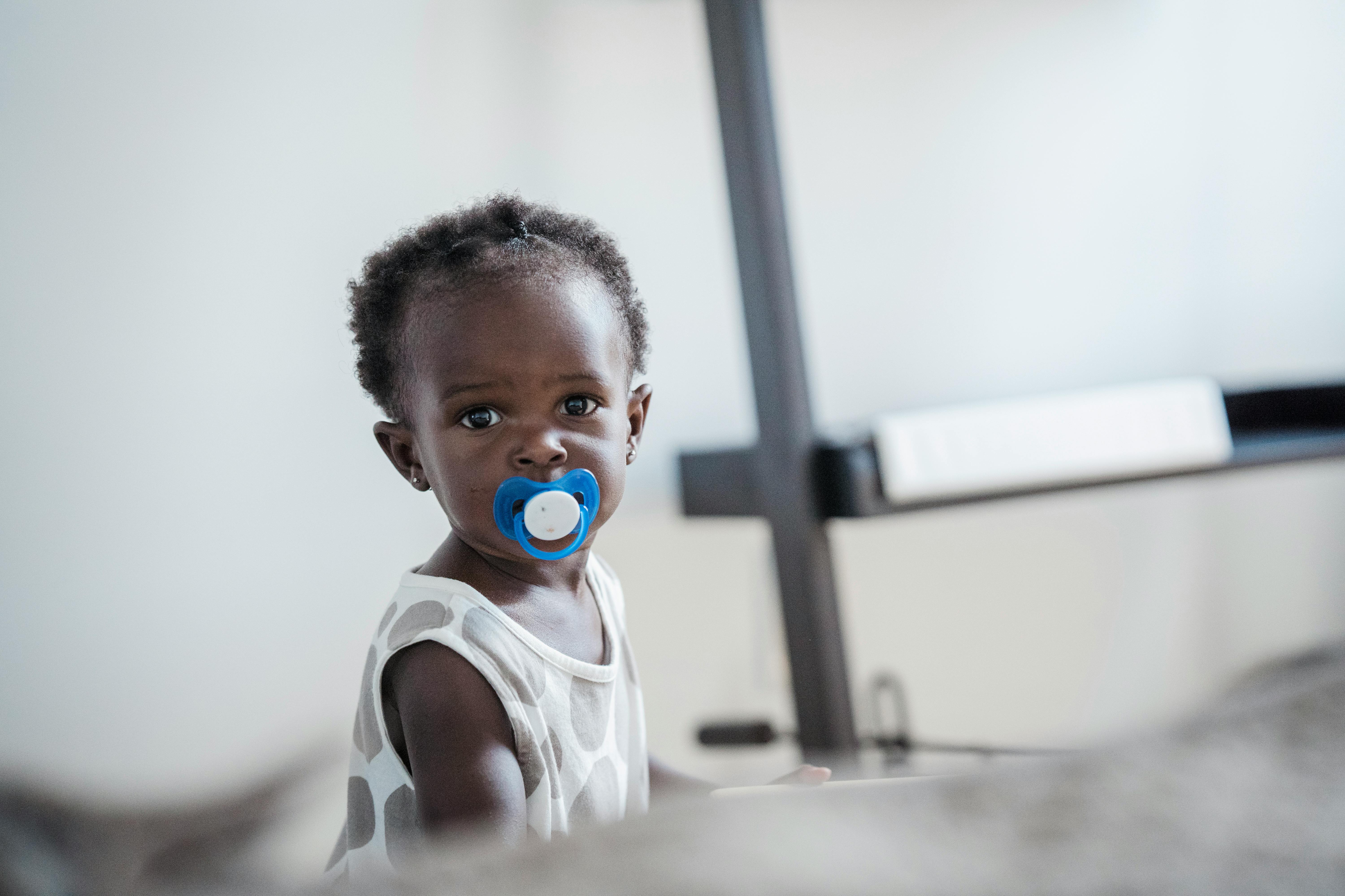 Cute Baby Girl with a Dummy in Her Mouth · Free Stock Photo