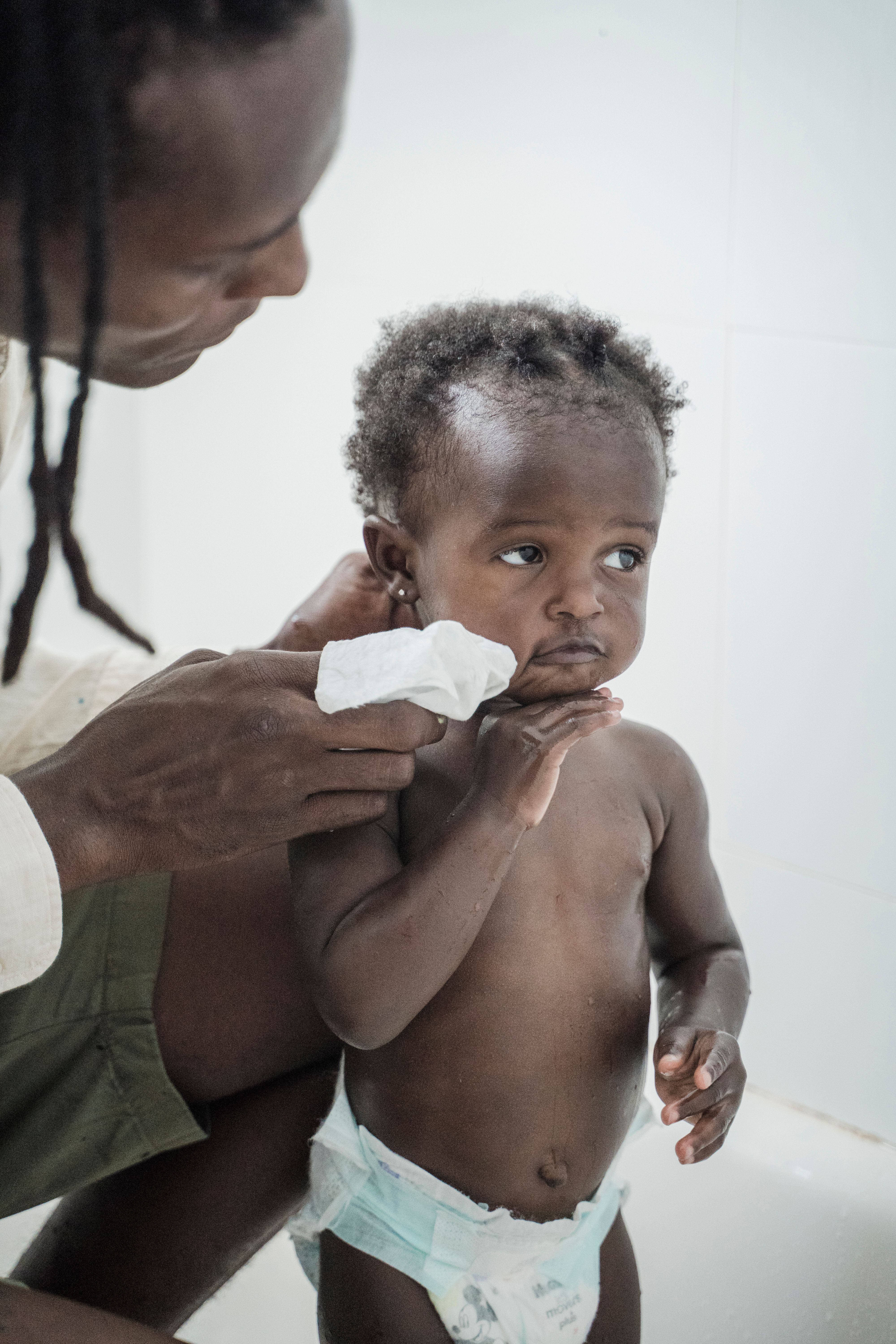Man Wiping a Baby's Face · Free Stock Photo