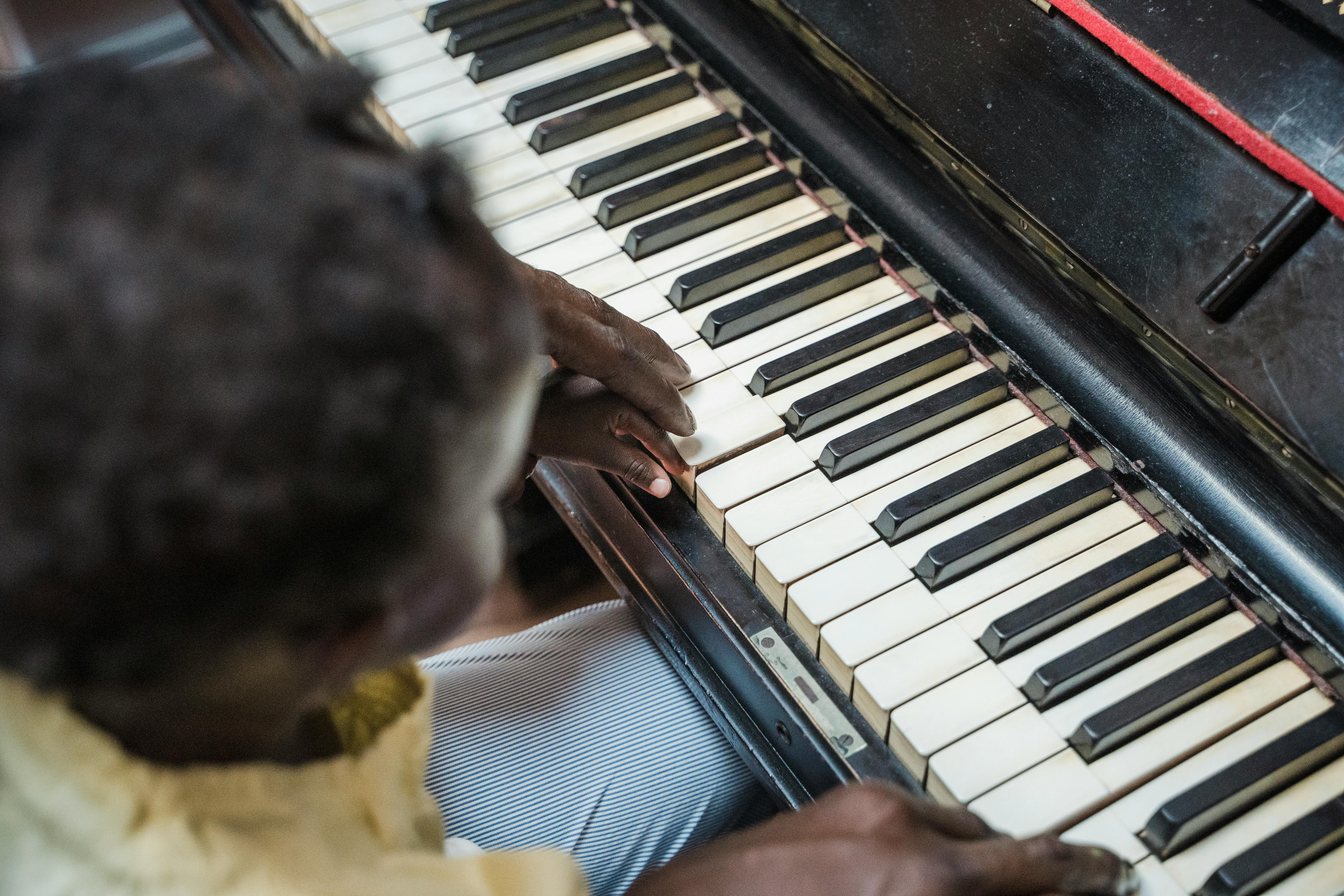 Close-Up Shot of a Person Playing Piano · Free Stock Photo