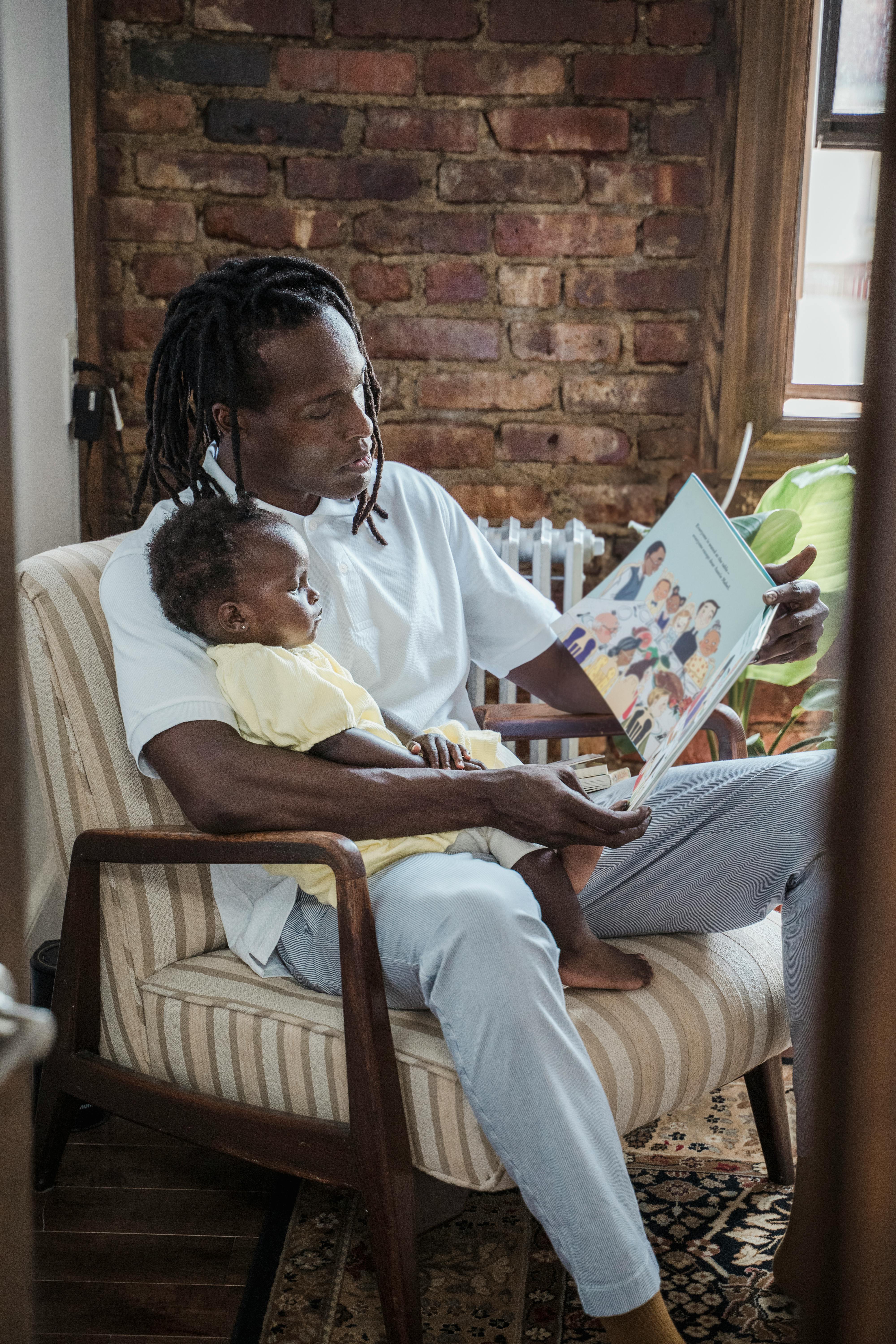 A Father Reading a Book to His Child · Free Stock Photo