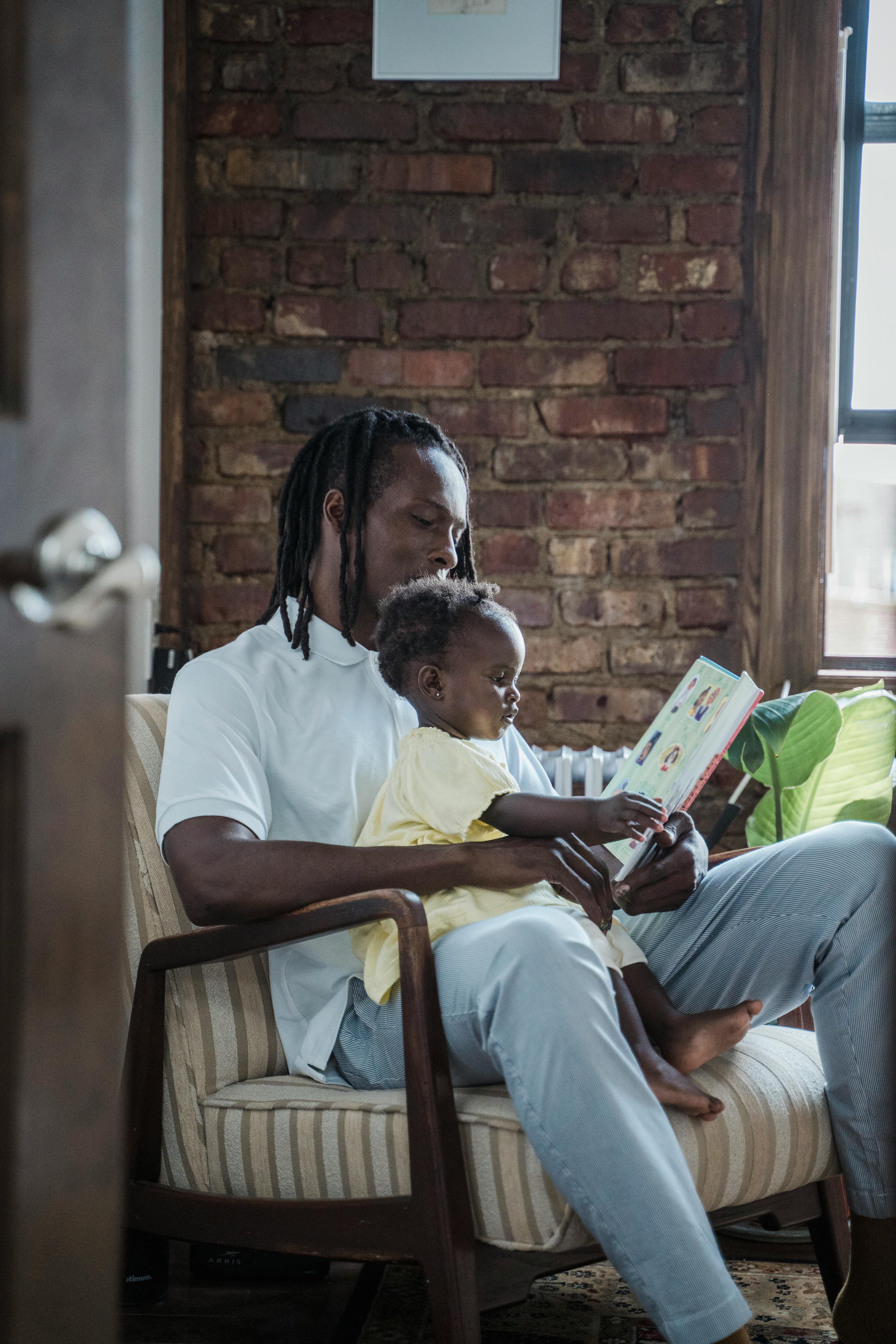 A Father Reading a Book to His Child · Free Stock Photo
