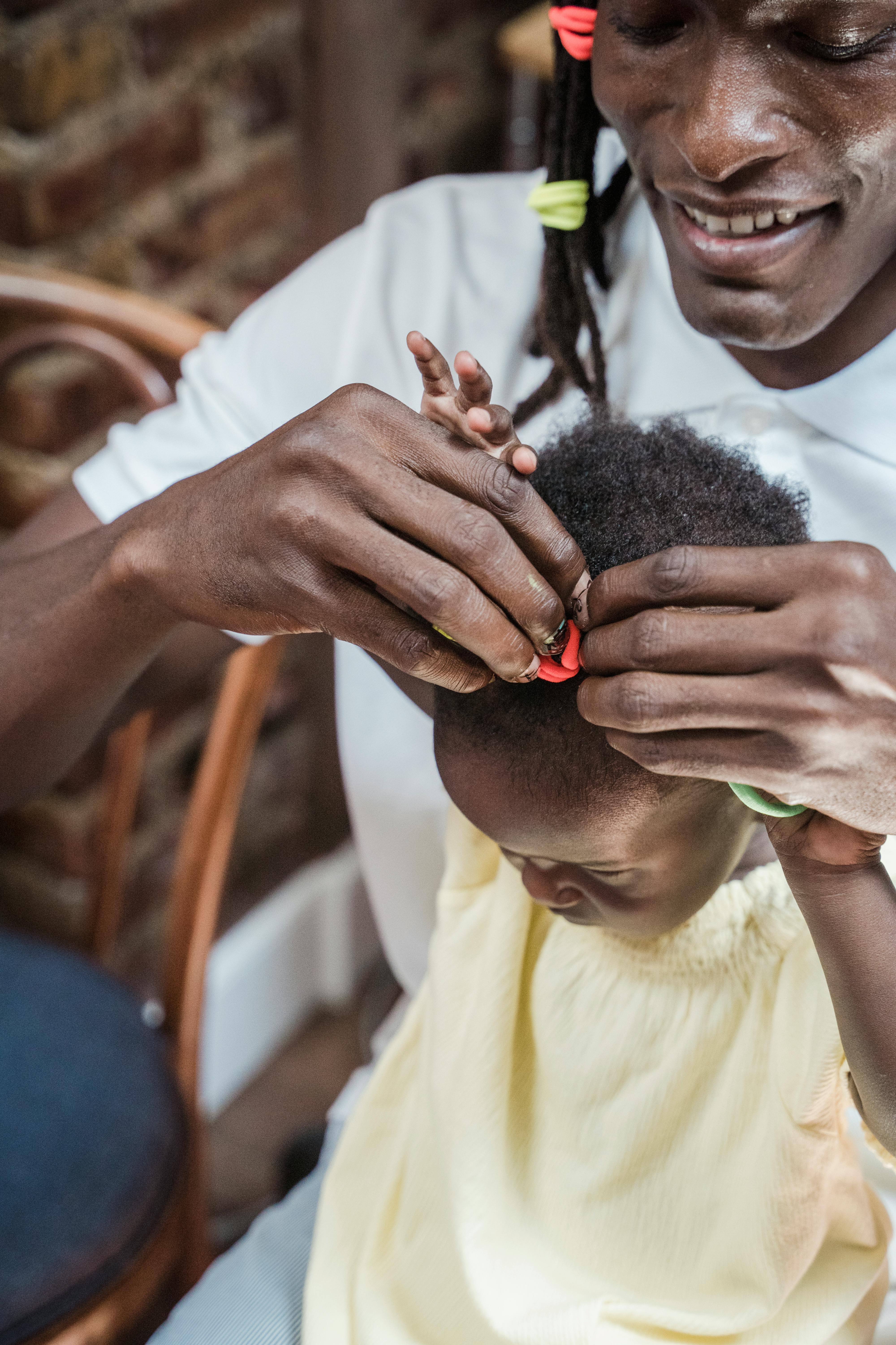 A Man Fixing His Daughter's Hair · Free Stock Photo