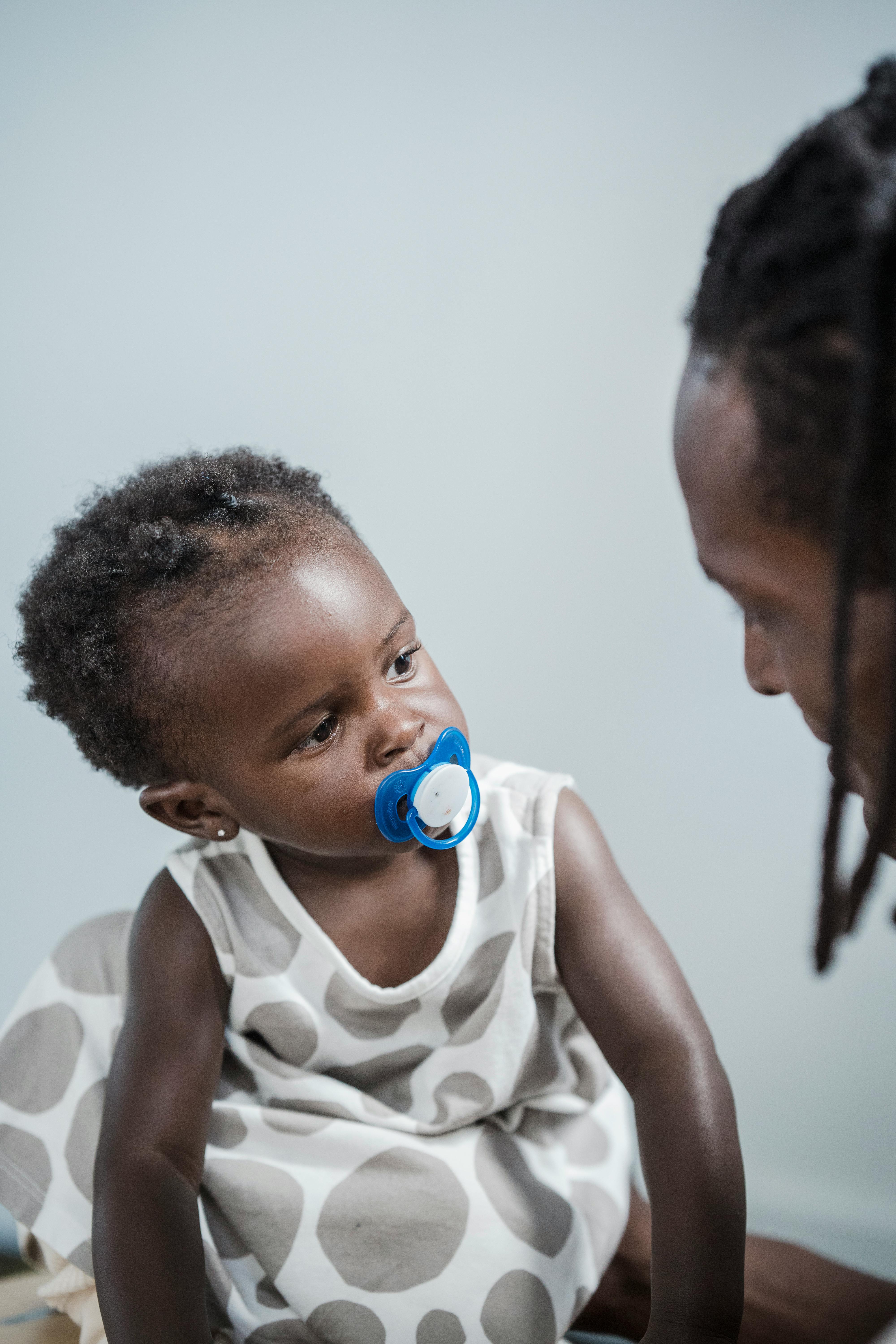 A Young Girl using a Pacifier · Free Stock Photo