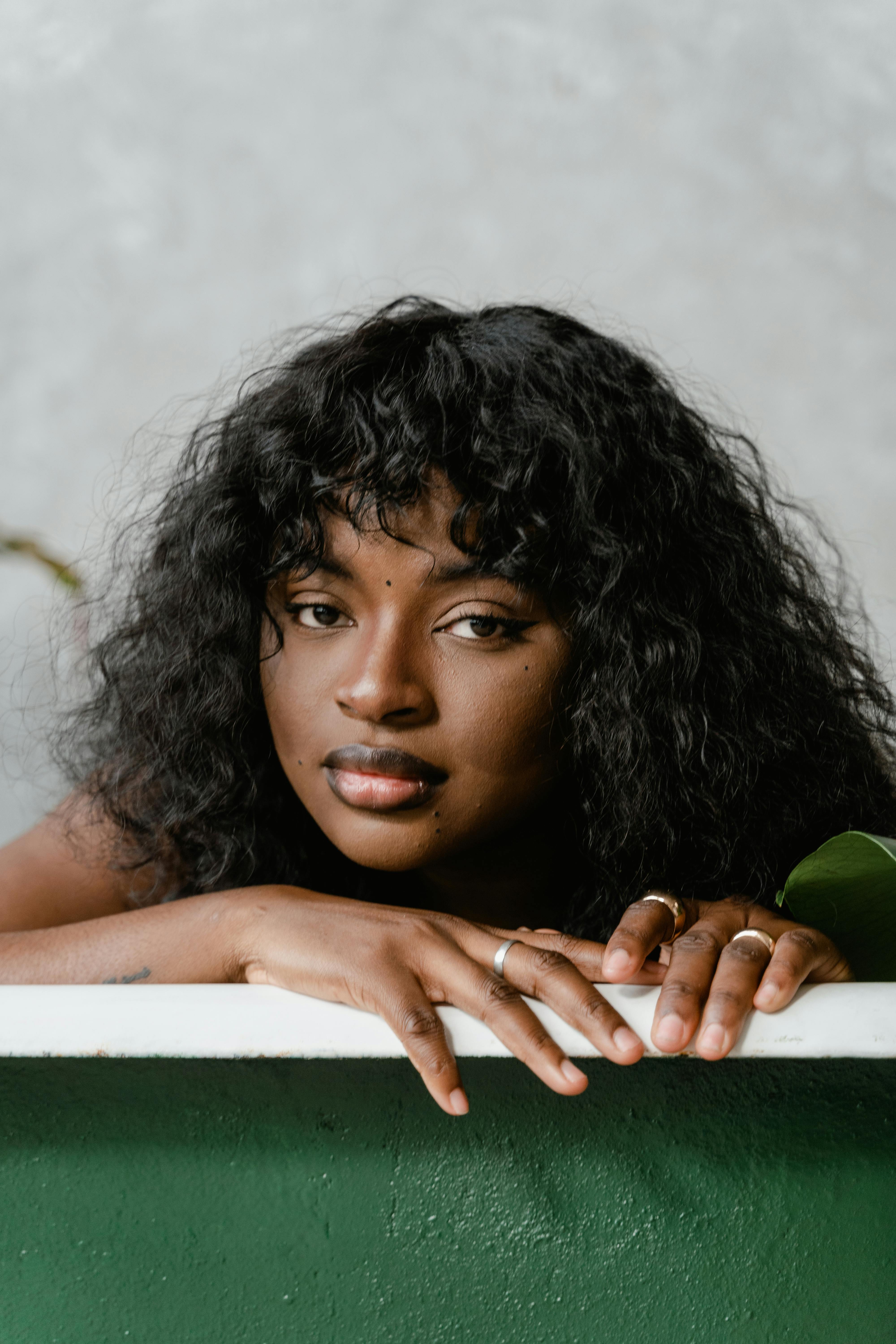 A Woman with Curly Hair Reading a Magazine · Free Stock Photo