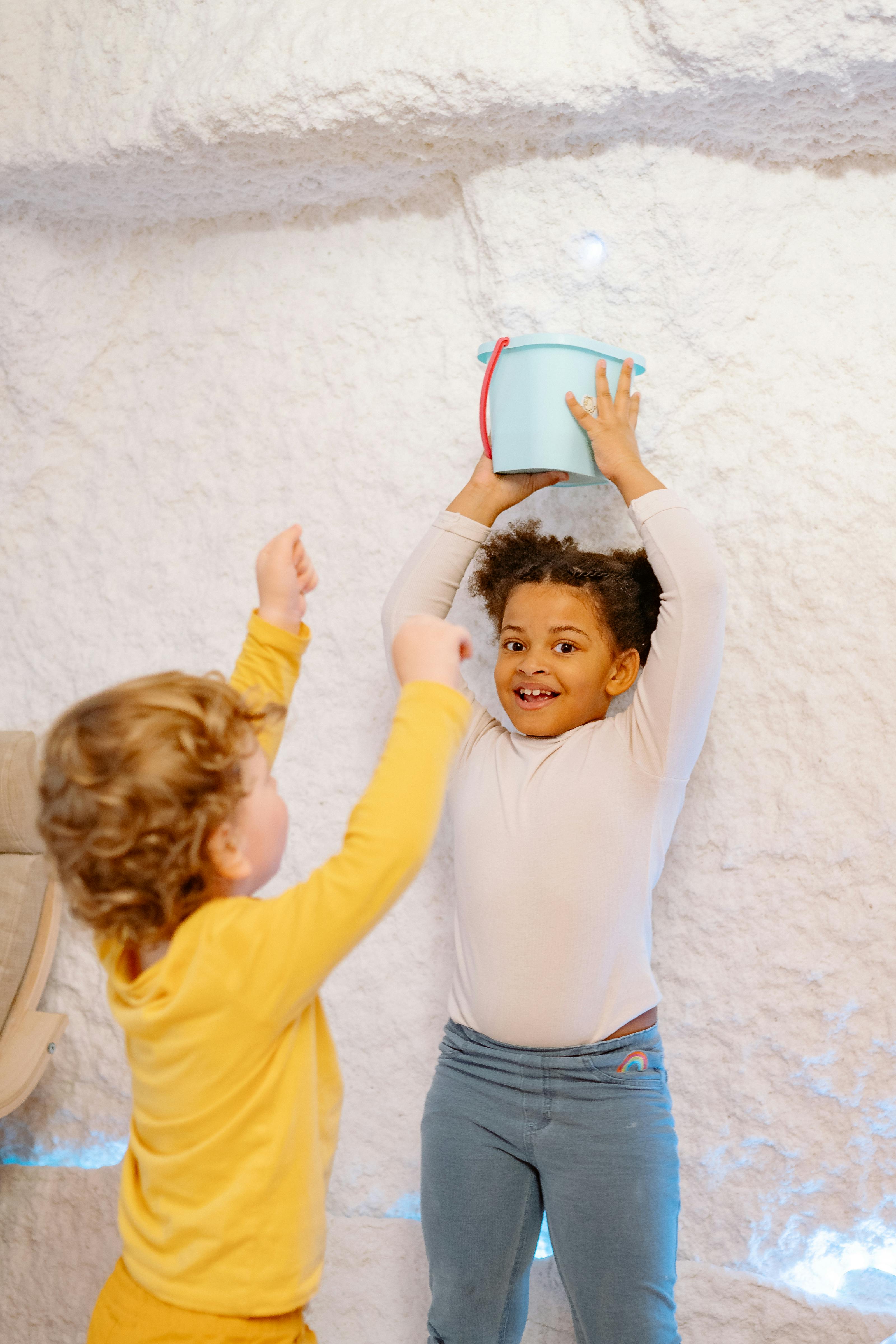 Children Playing with a Bucket Container · Free Stock Photo