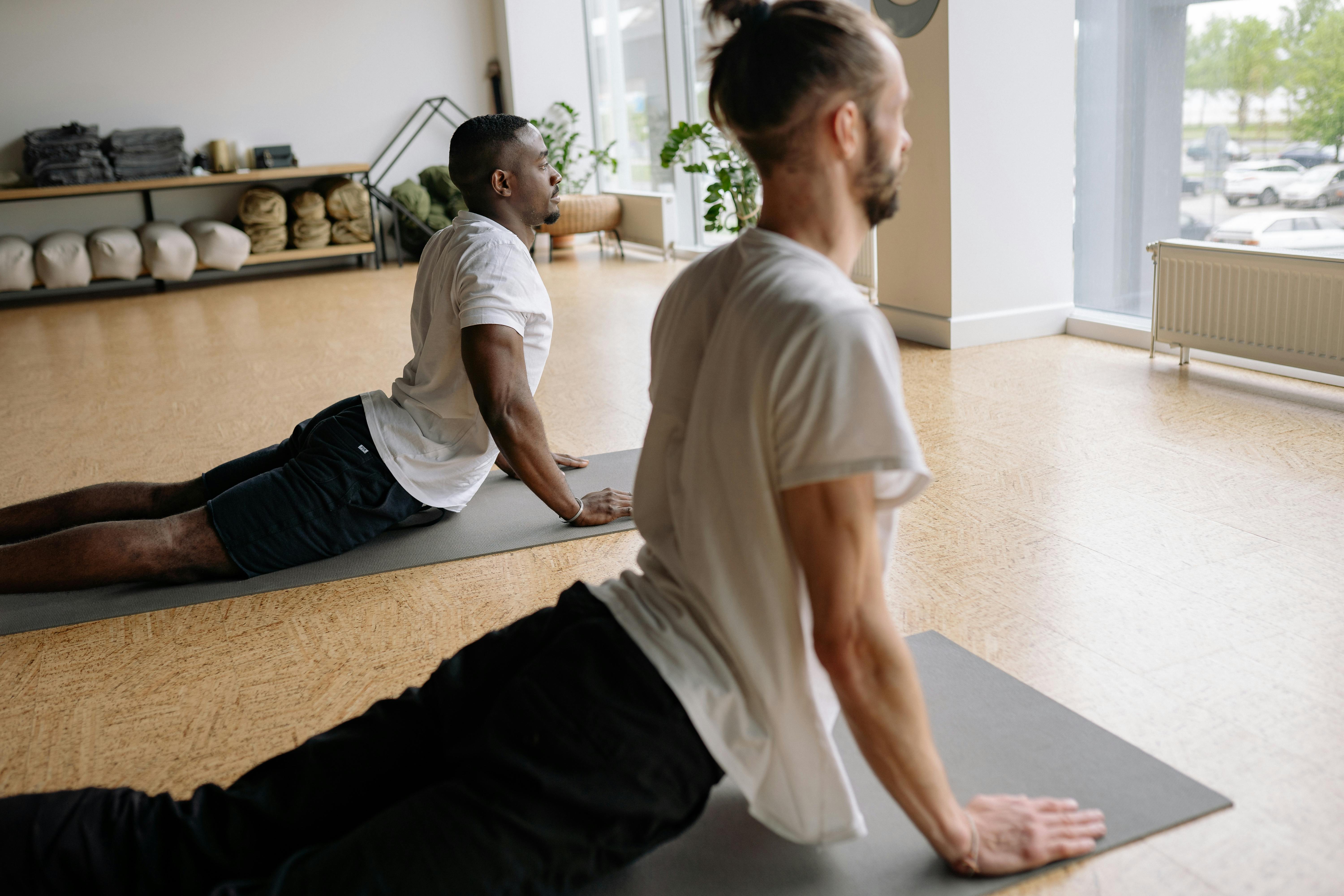 Men Stretching on a Yoga Mat · Free Stock Photo