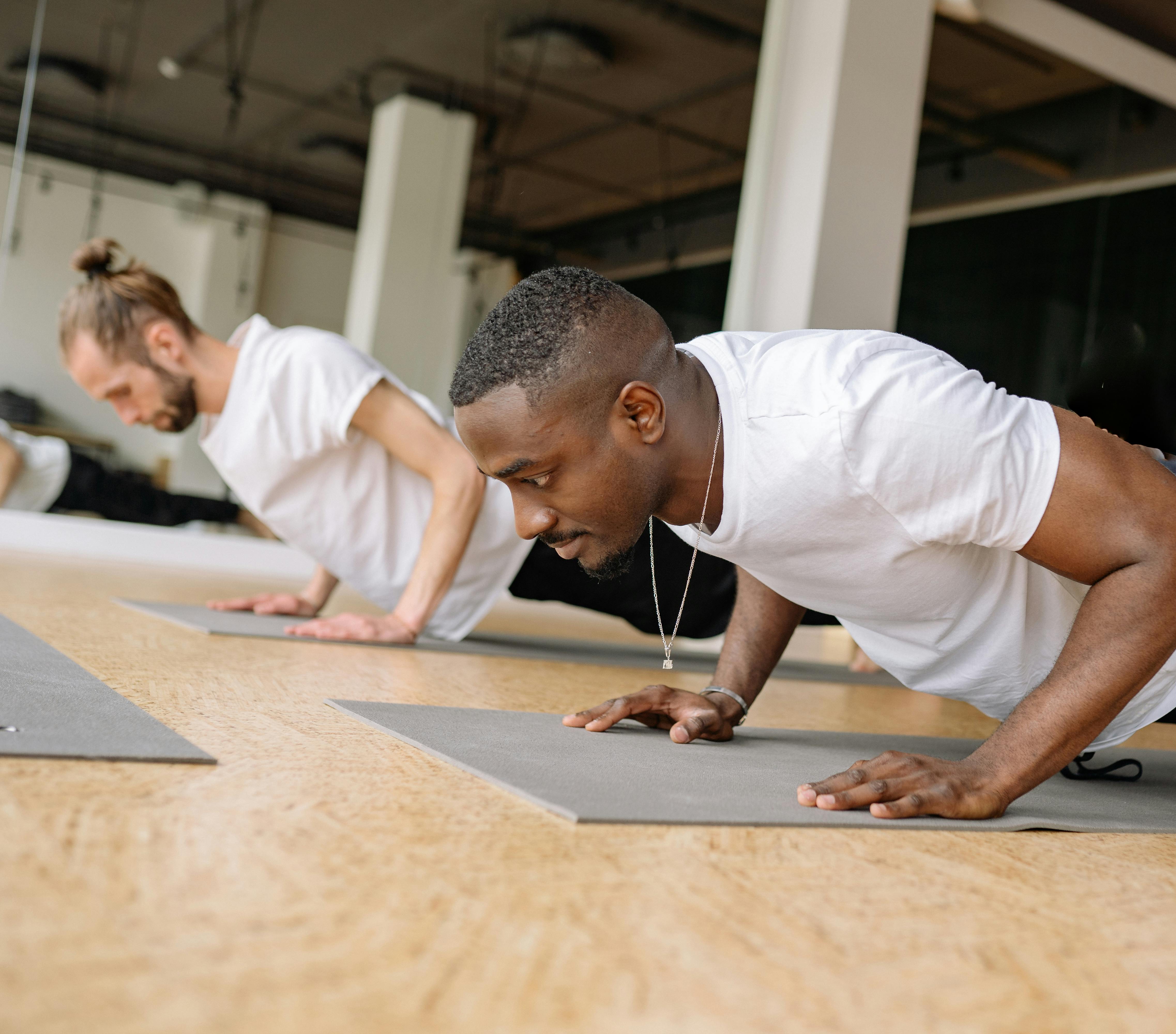 Two Men Doing Push-ups · Free Stock Photo