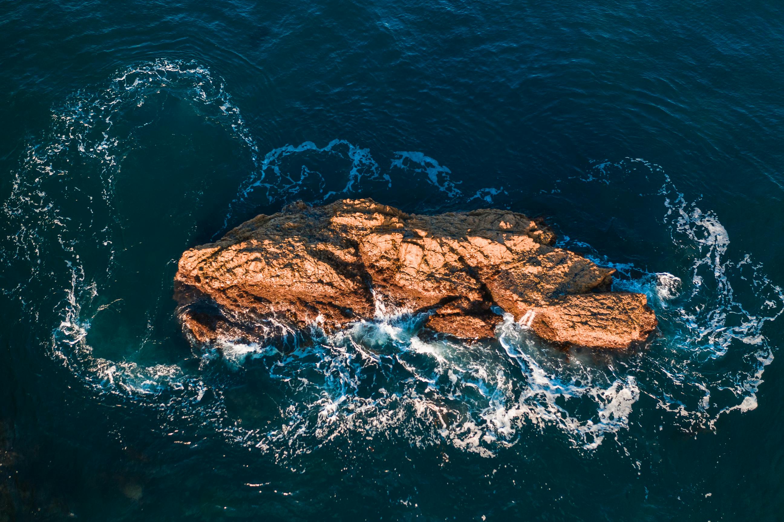 A Big Rock Formation in the Sea · Free Stock Photo