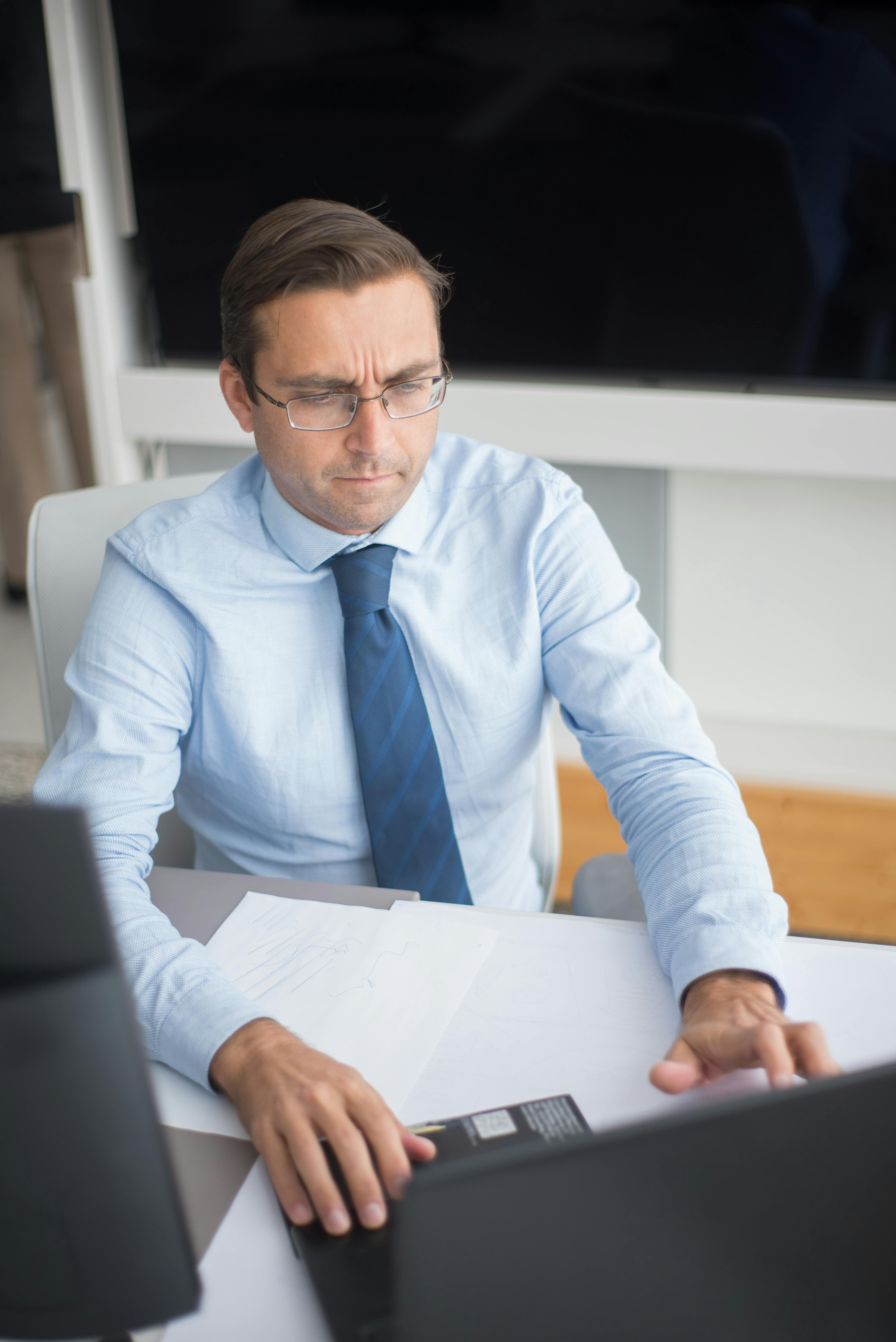 Man in Blue Dress Shirt Using Laptop · Free Stock Photo